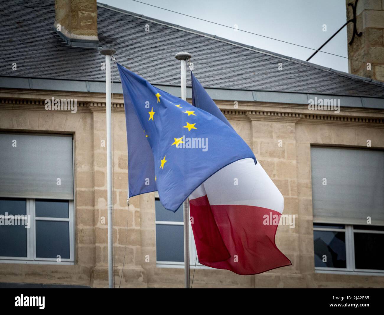 Picture of a French flag standing next to a European flag with its ...