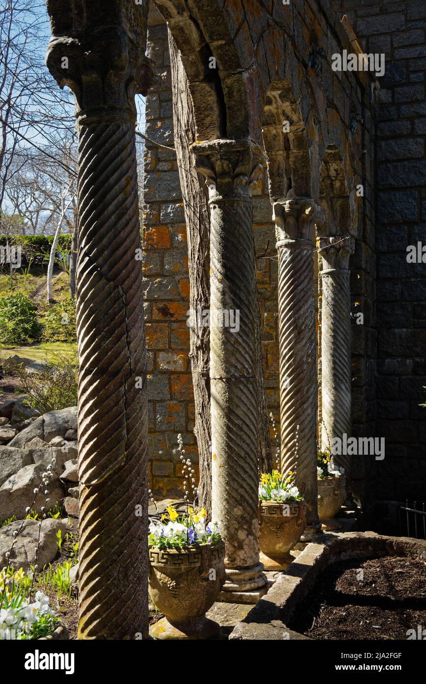 Beautiful stone columns surrounded by colorful flowers at golden hour ...