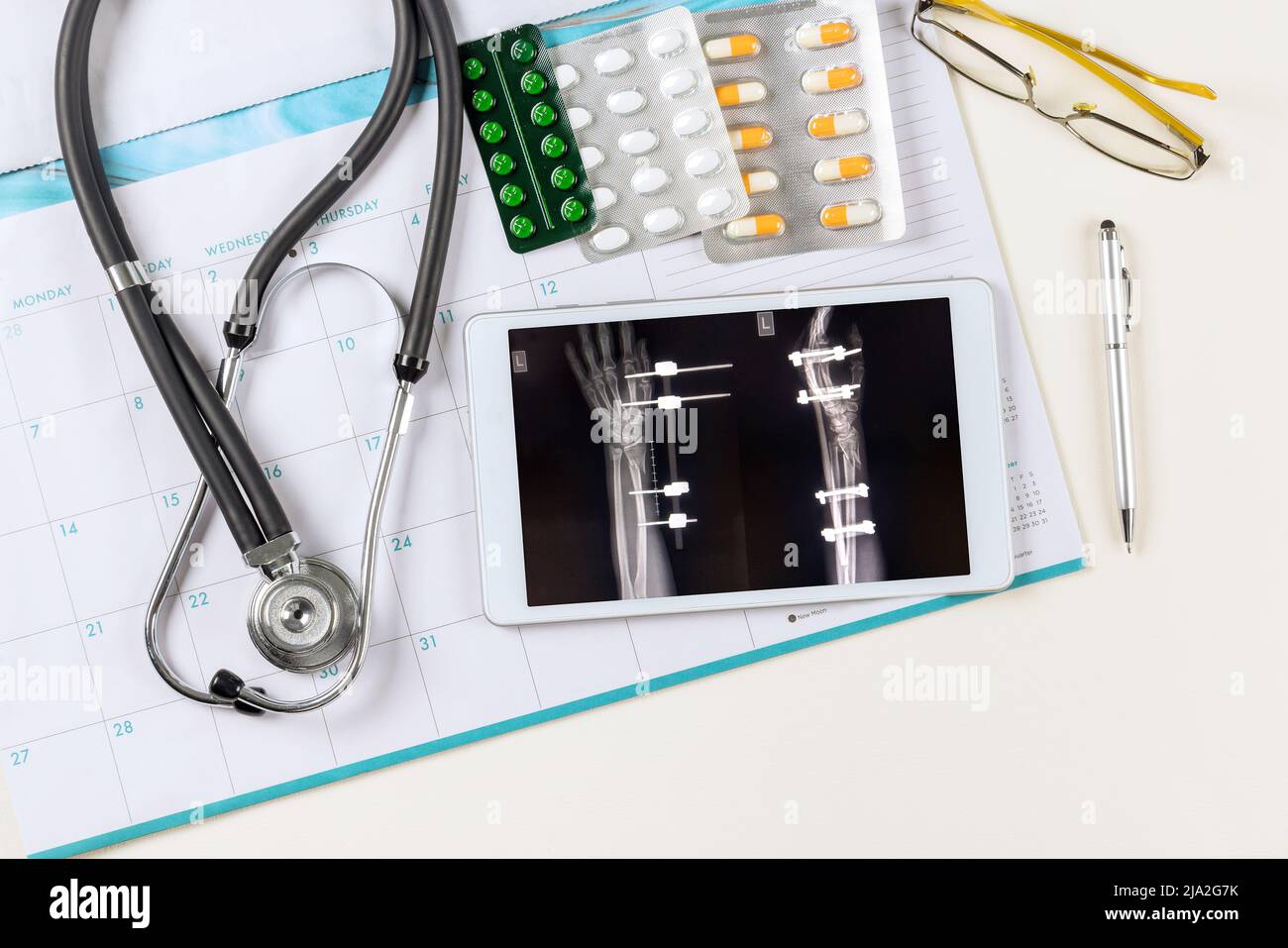 X-ray image on doctors using digital tablet of doctor desk table with ...