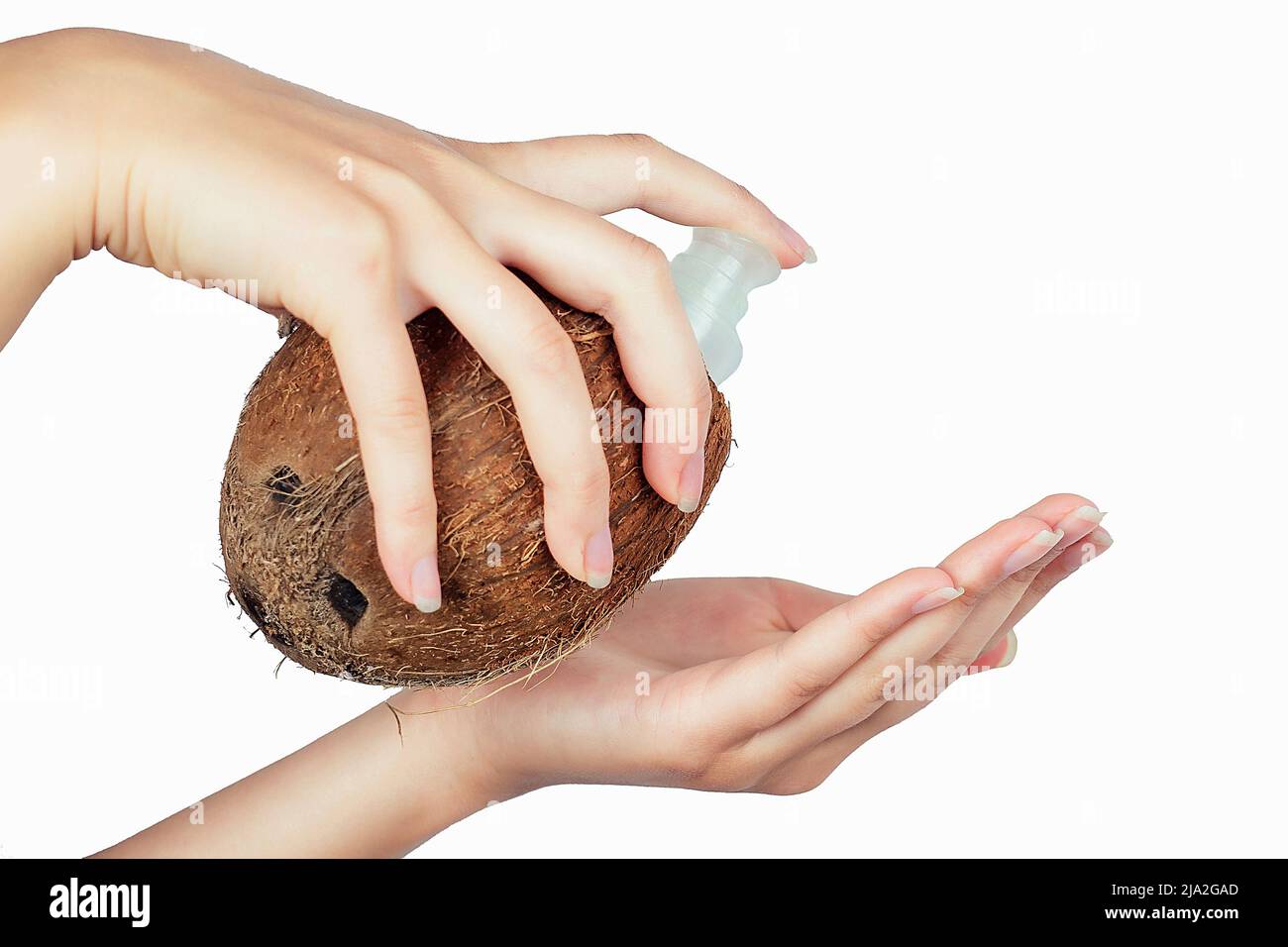 coconut oil bottle and cap in a hand on white isolate Stock Photo - Alamy