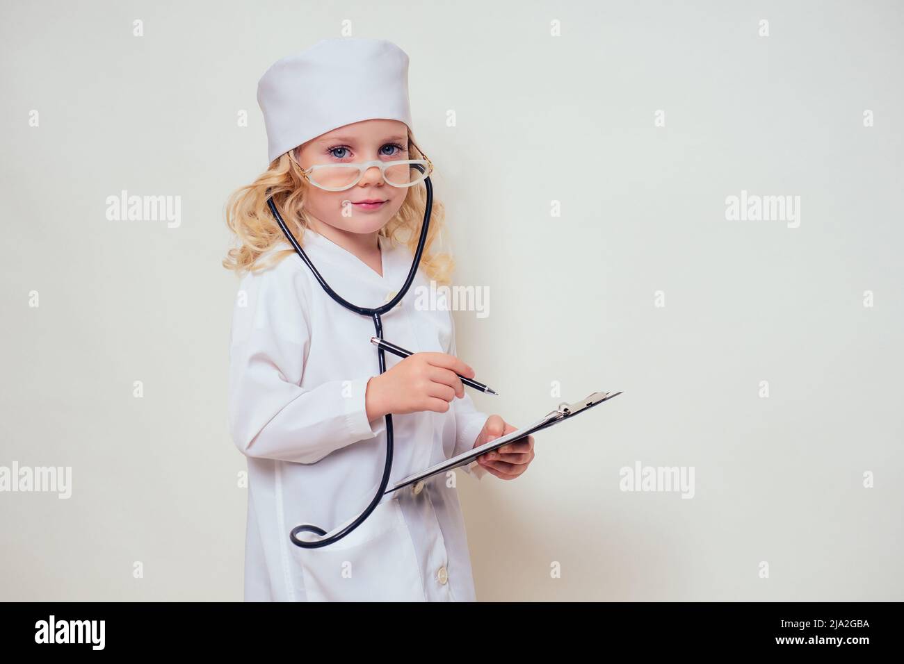 smiling little girl in doctor uniform with medical tools stethoscope ... smiling little girl in doctor uniform with medical tools stethoscope ...