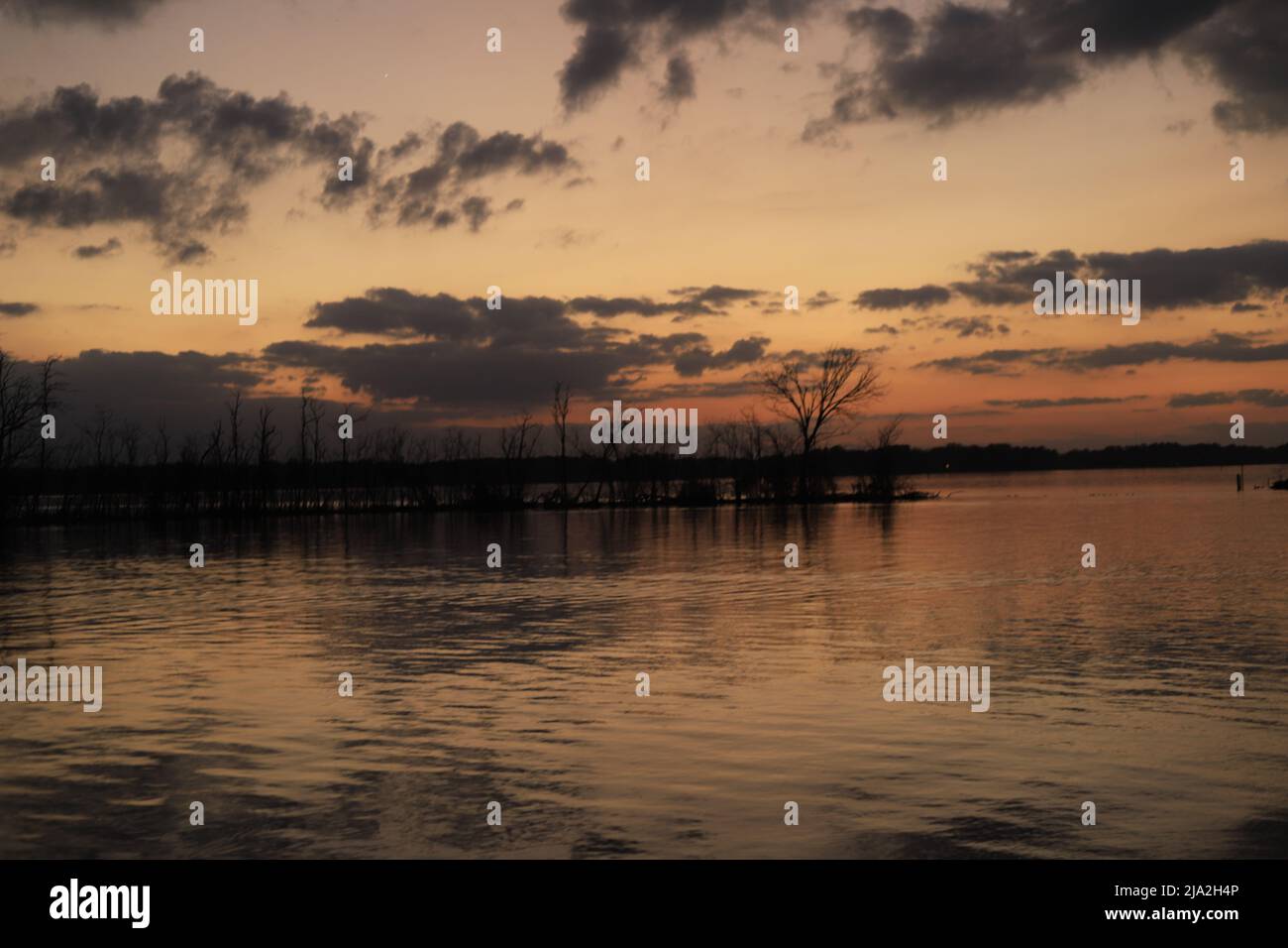 Sunset by a lake Stock Photo - Alamy