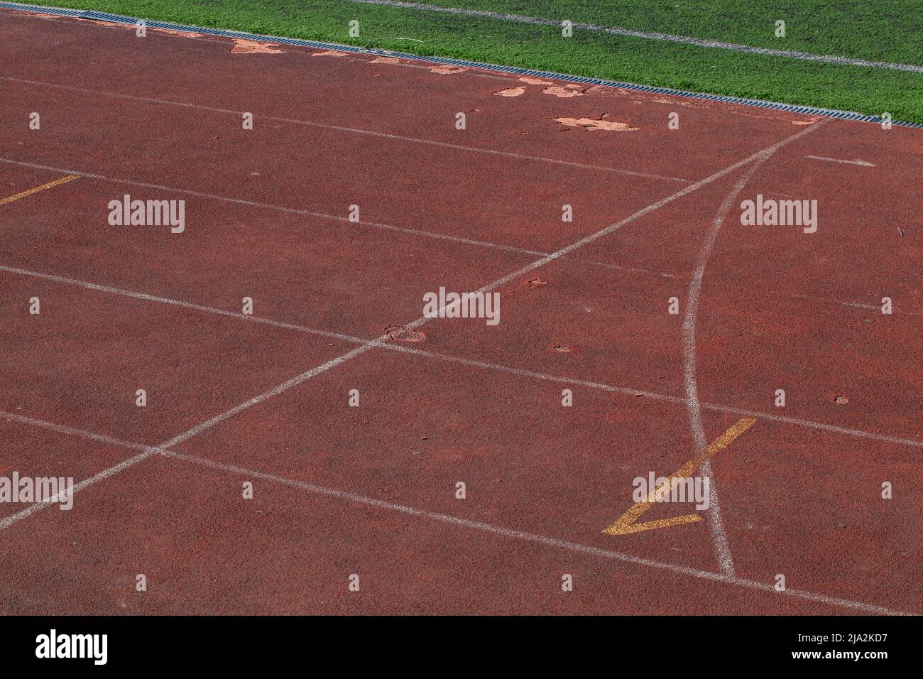 the red surface of the old running track at the stadium, the running ...