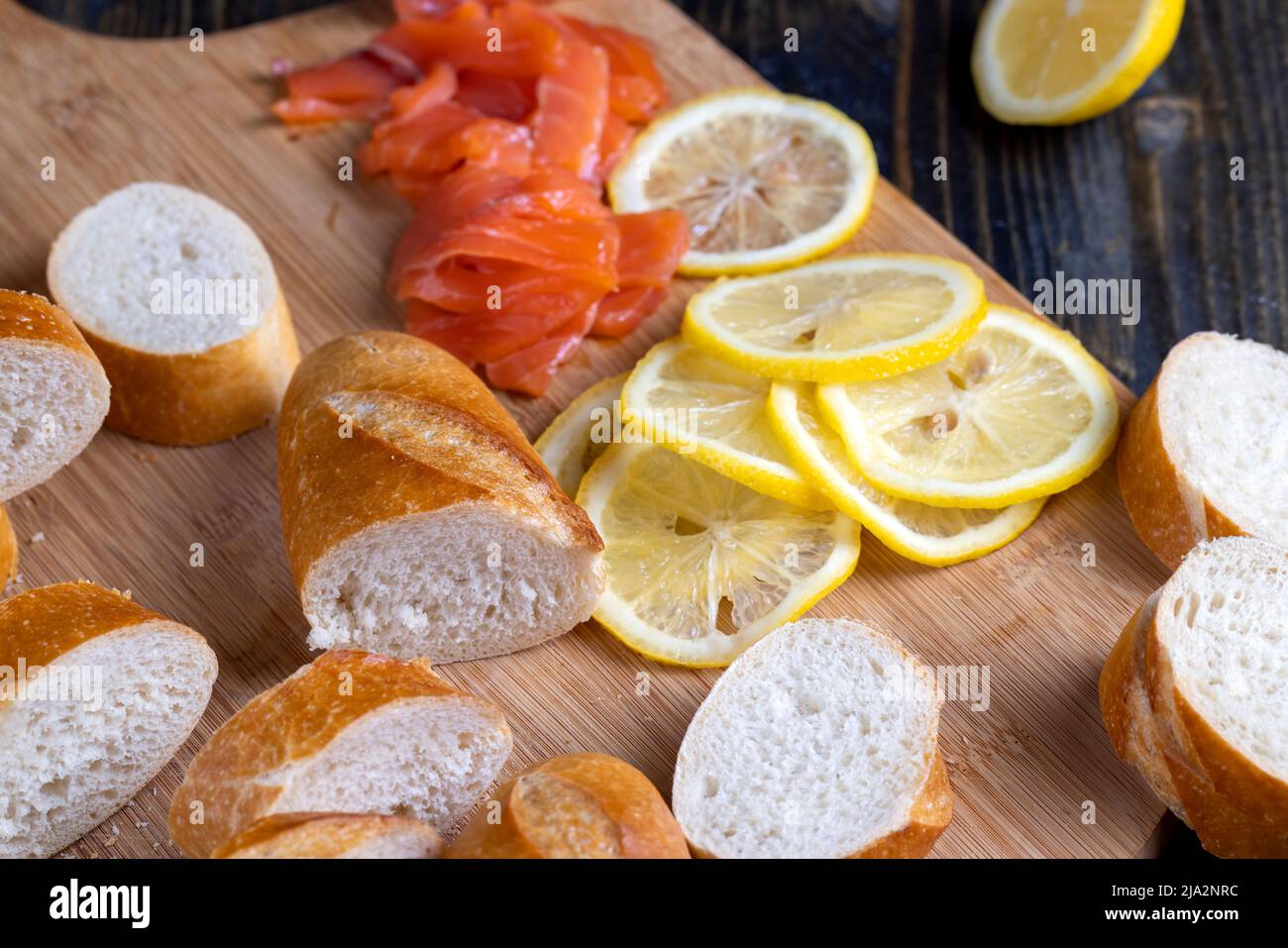 sliced red salted salmon during cooking, cutting fish fillets during ...
