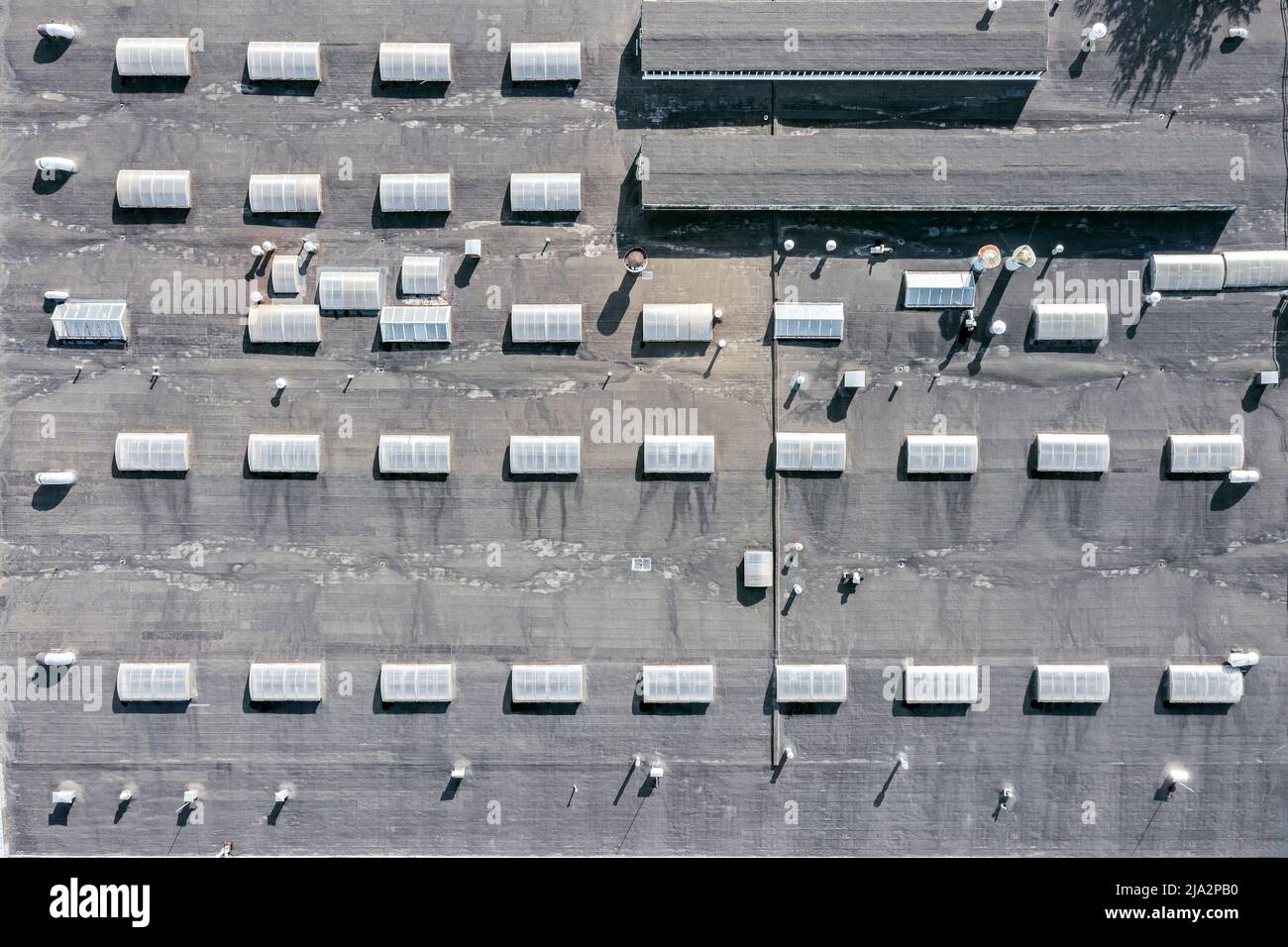 aerial view of large industrial factory roof with skylights and ...