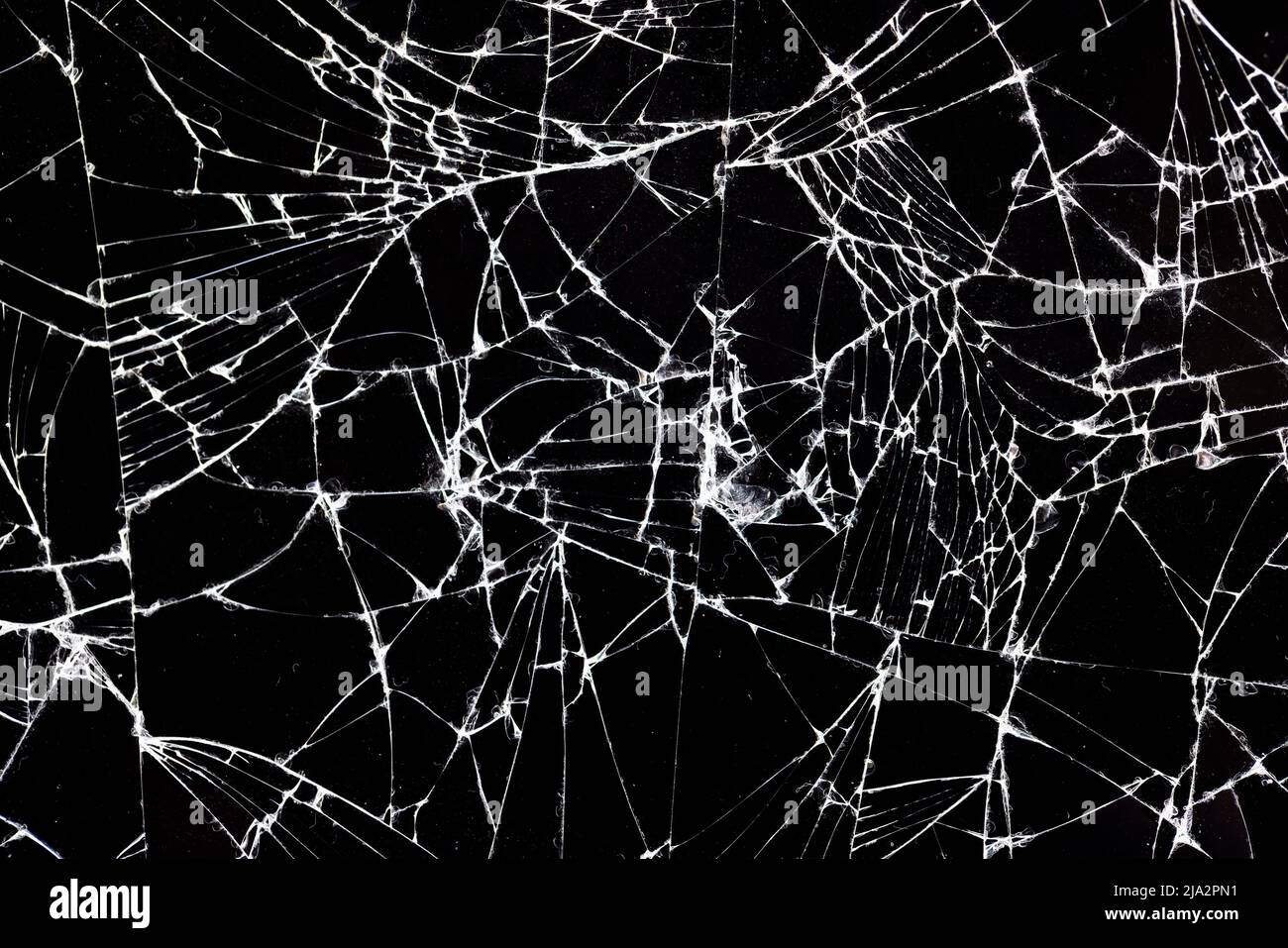 old dirty glass with a lot of cracks, old broken glass on a black ...