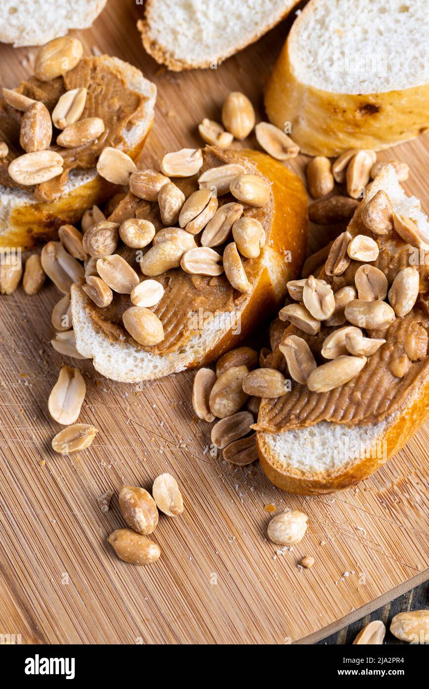 wheat fresh baguette and peanut paste, making breakfast of bread and ...