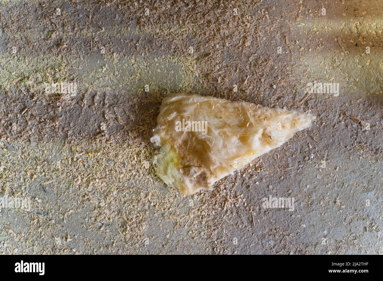 A piece of glass wool in the shape of an arrow lies on the floor Stock ...