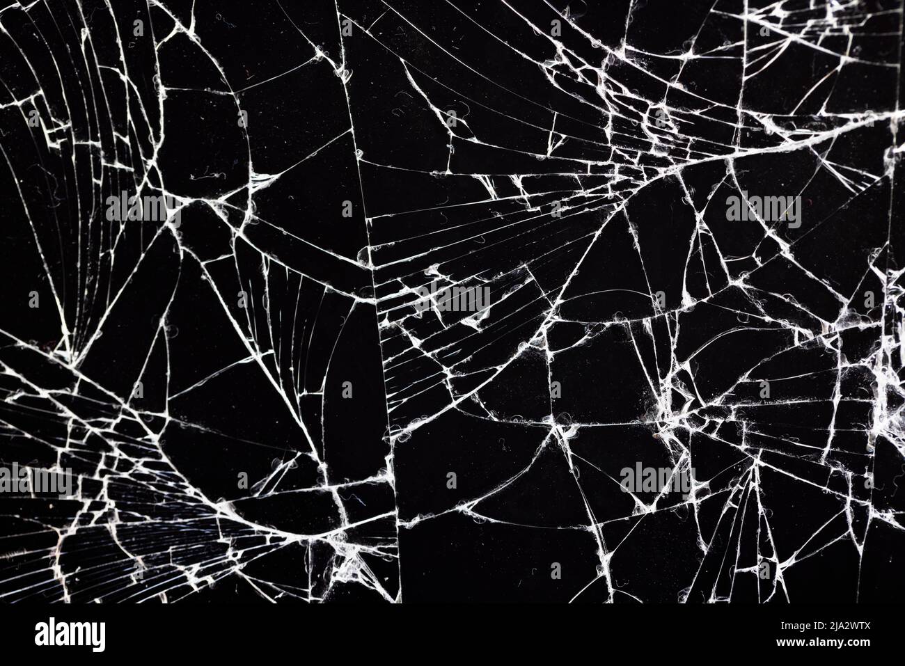 old dirty glass with a lot of cracks, old broken glass on a black ...