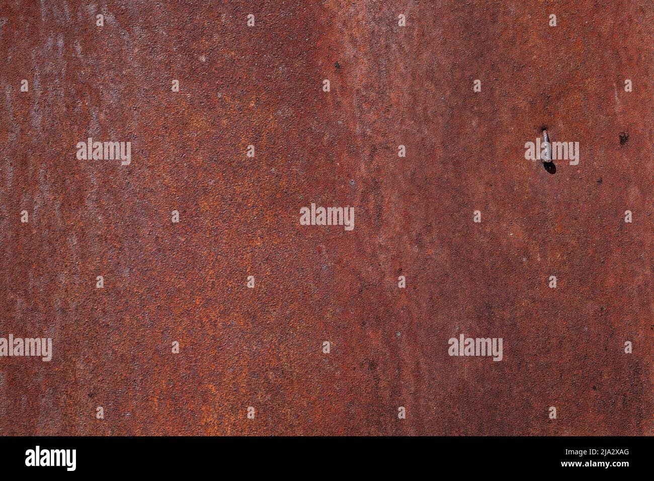 rusty metal surface, part of a building made of metal sheets that have ...