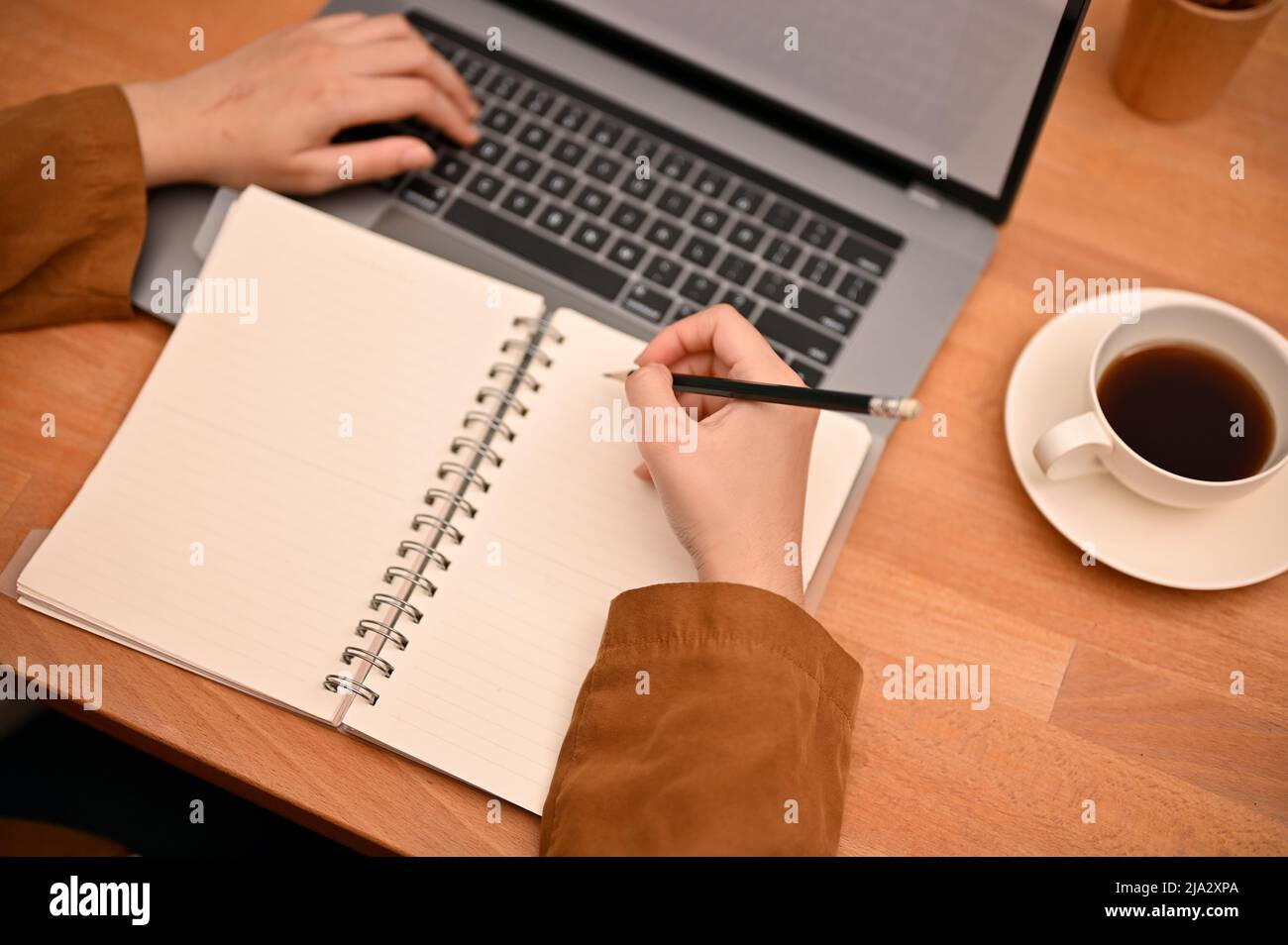 Top view, Female university student doing her homework, writing and ...