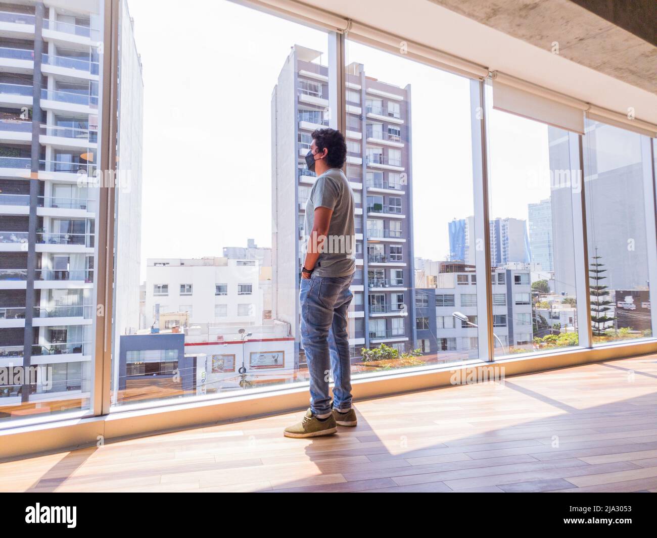 Silhouette man looking through window hi-res stock photography and ...