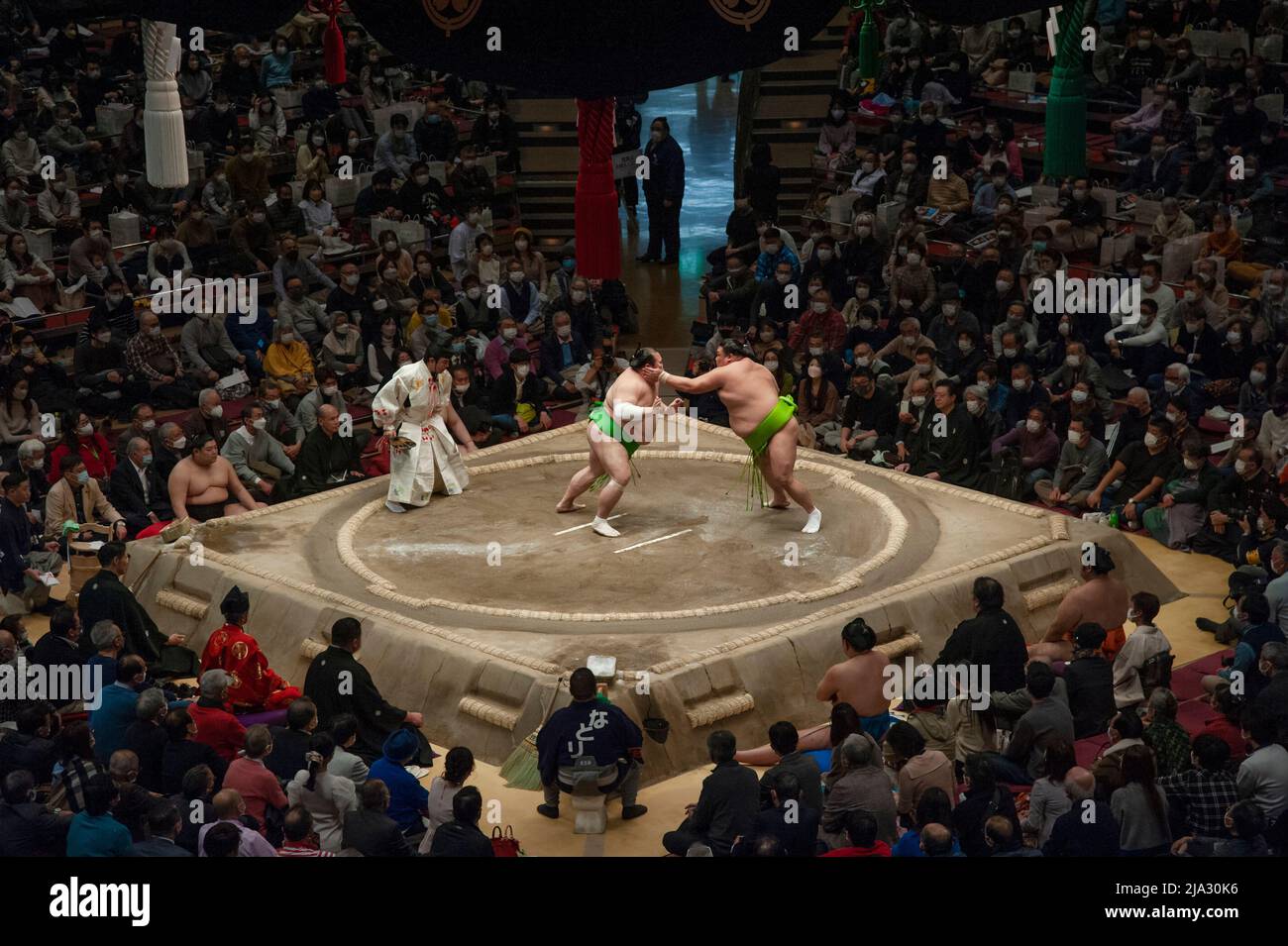 A sumo wrestler slaps his opponent during a bout in Tokyo in January ...
