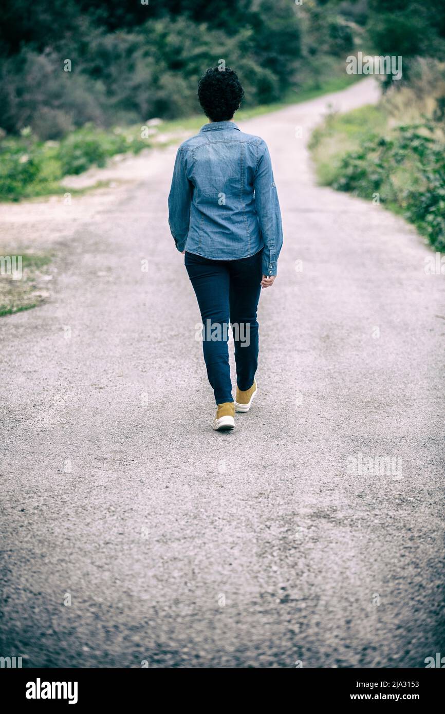 Woman walking away Stock Photo - Alamy