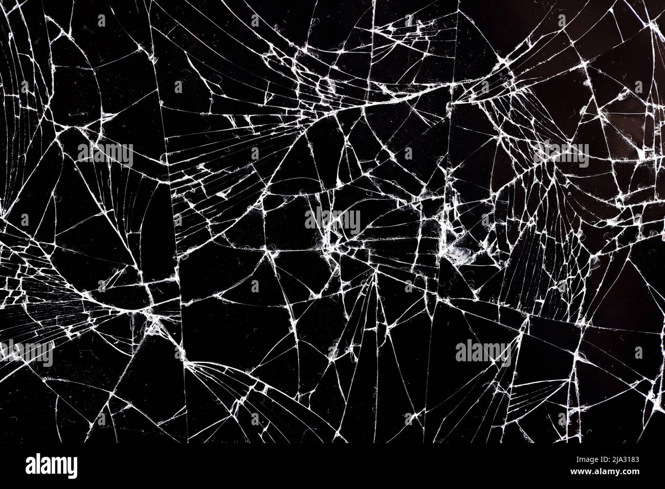 old dirty glass with a lot of cracks, old broken glass on a black ...