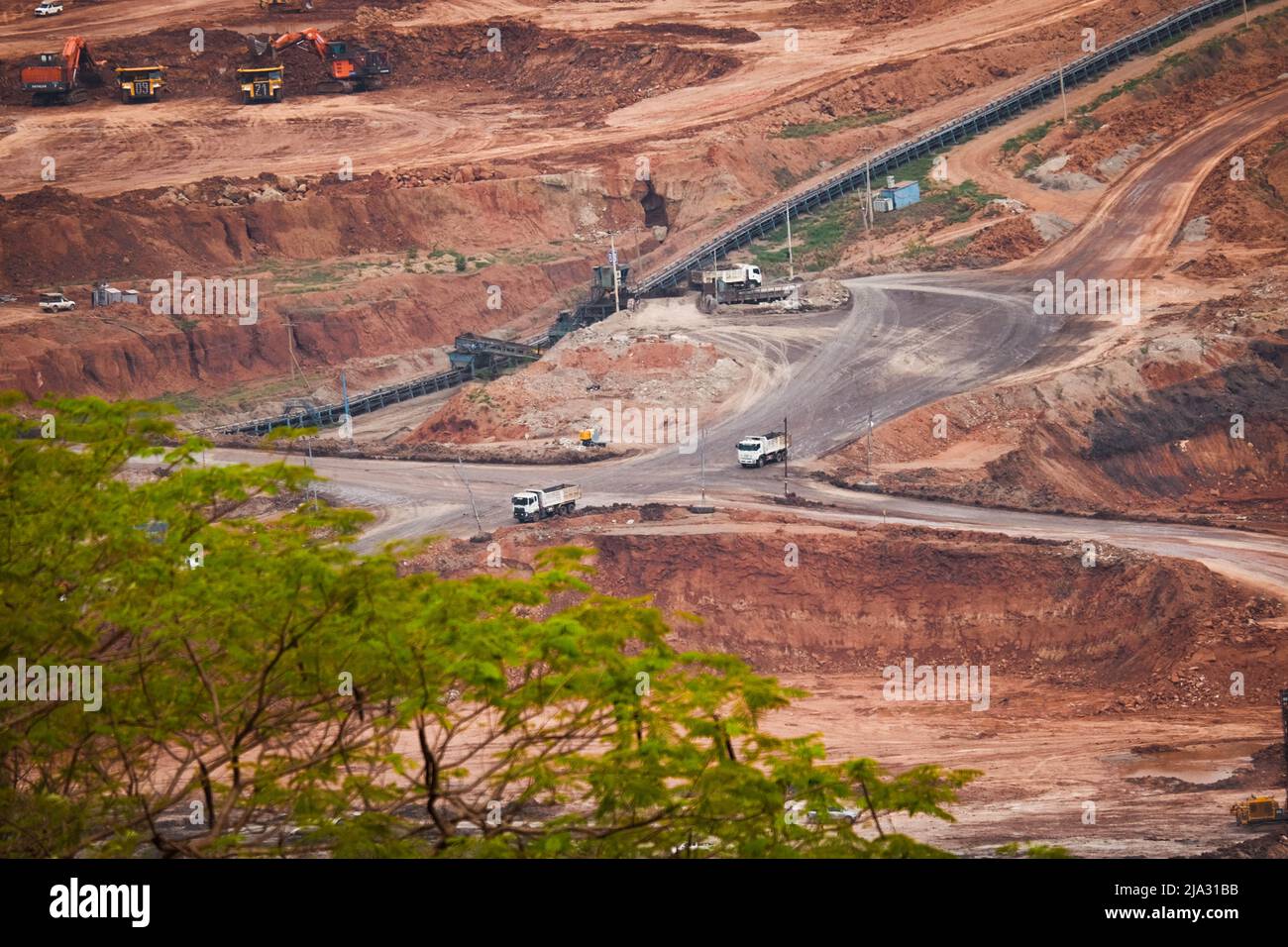 View of Trucks and excavators work in open pits in lignite coal mines ...