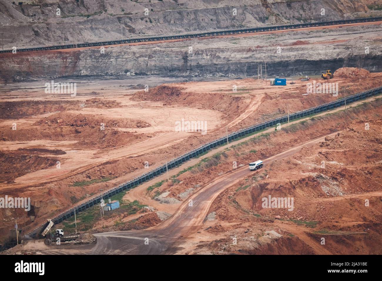 View of Trucks and excavators work in open pits in lignite coal mines ...
