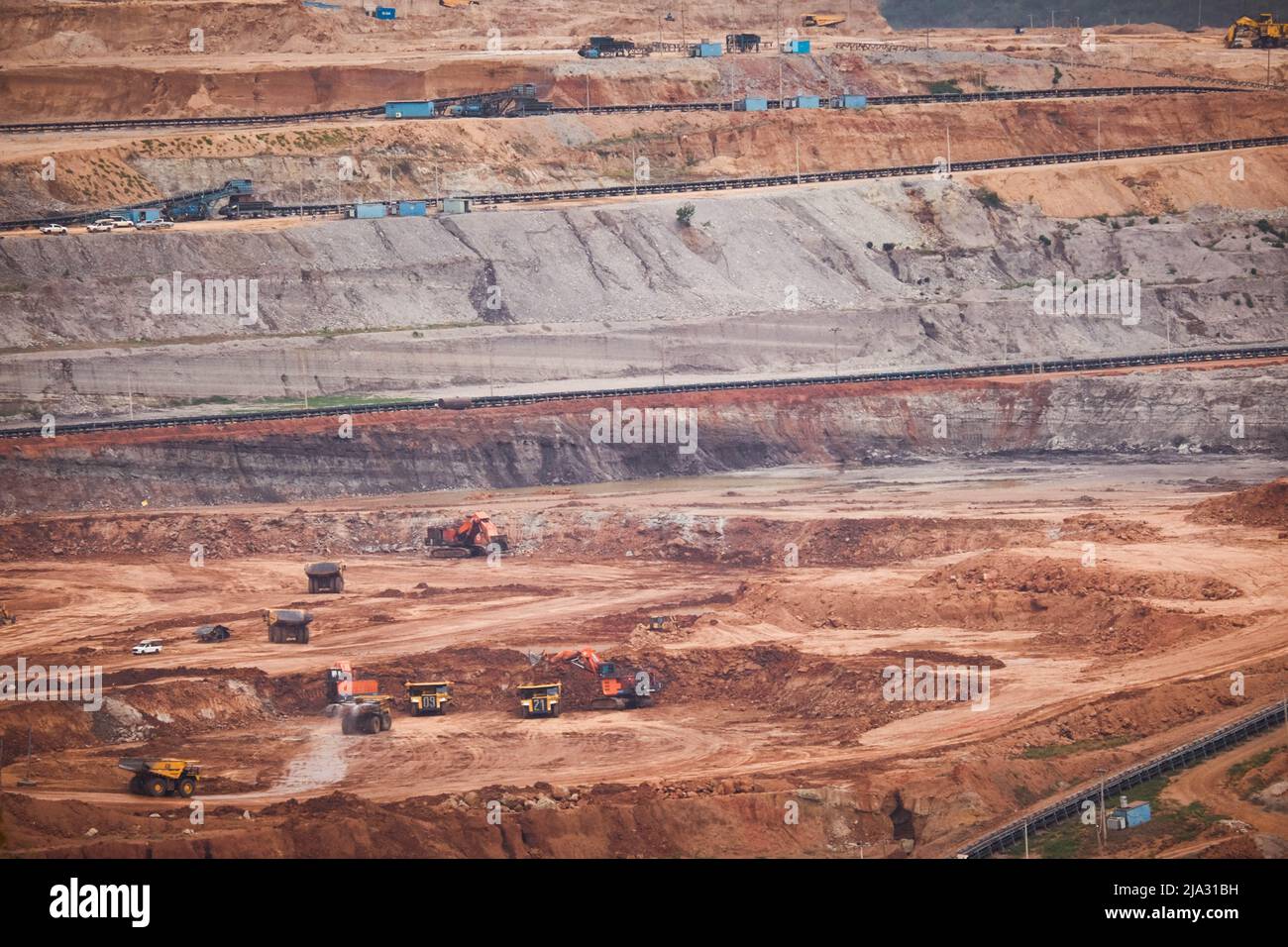 View of Trucks and excavators work in open pits in lignite coal mines ...