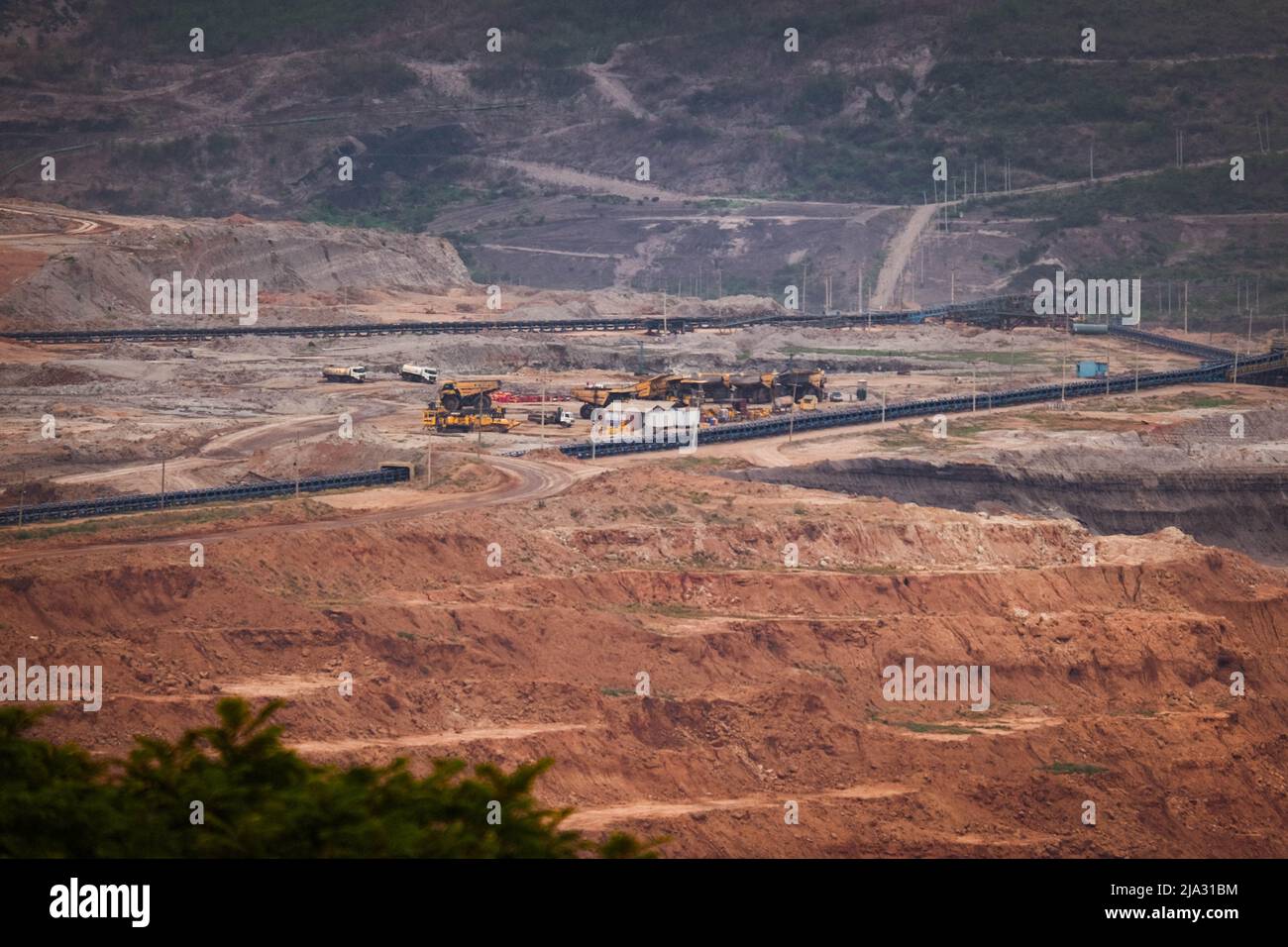 View of Trucks and excavators work in open pits in lignite coal mines ...