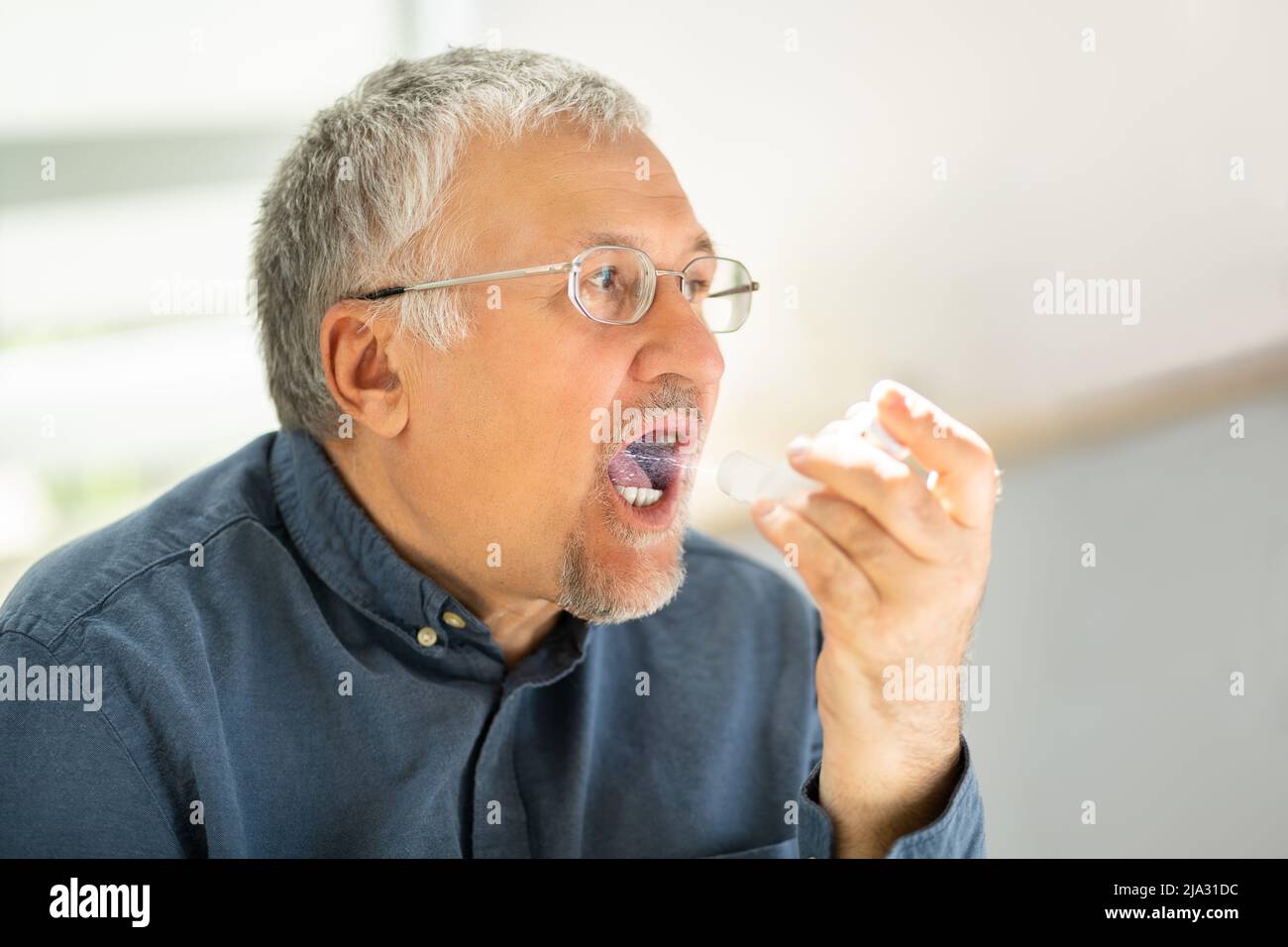 Close-up Of A Man Using Asthma Inhaler Stock Photo - Alamy