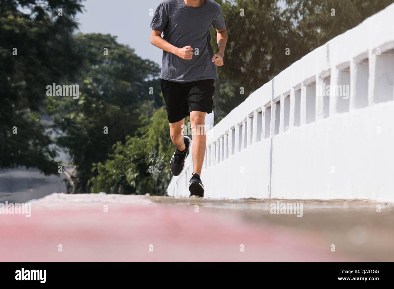 Young man runner feet running on the road be running for exercise ...