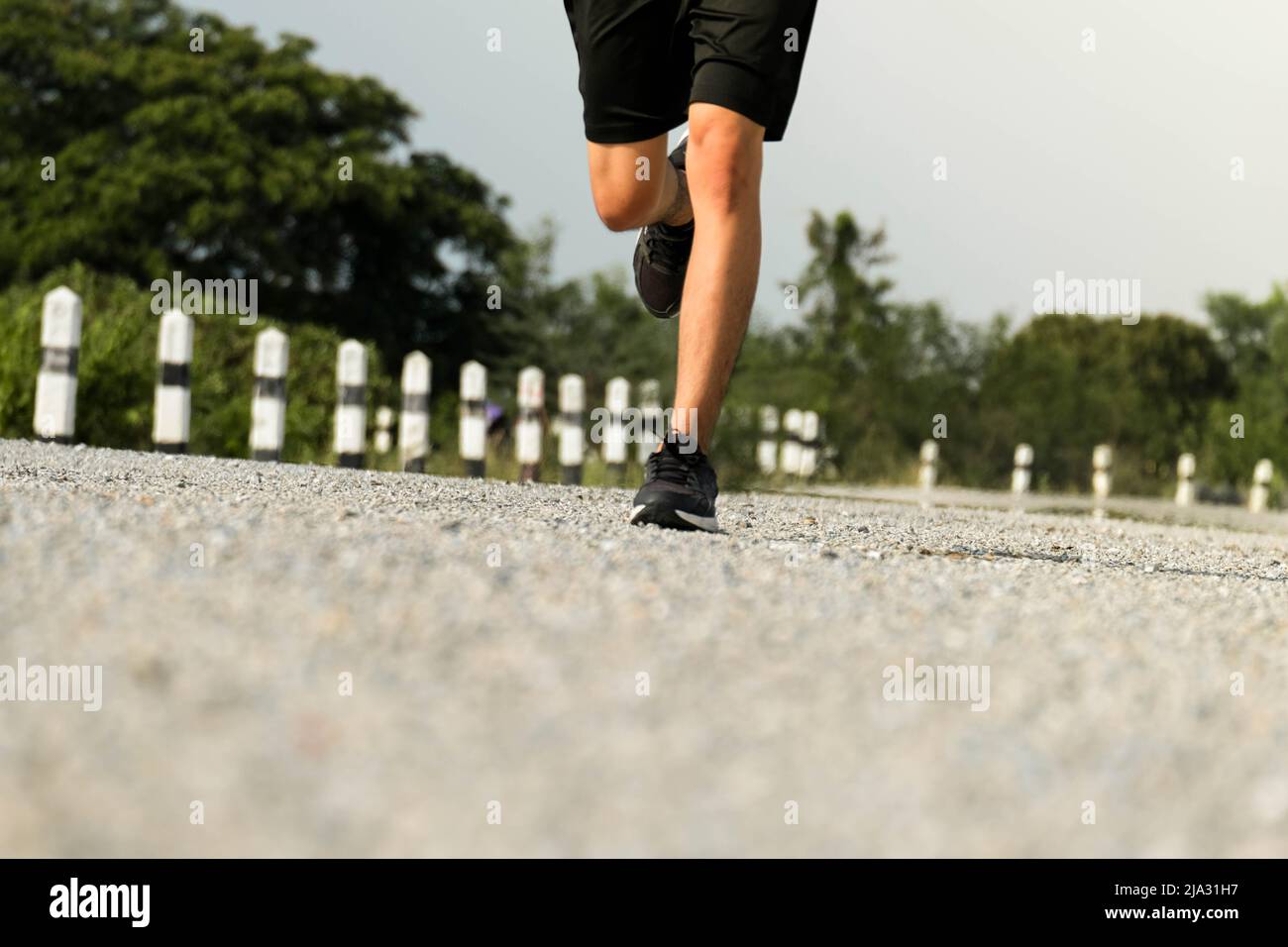Young man runner feet running on the road be running for exercise ...