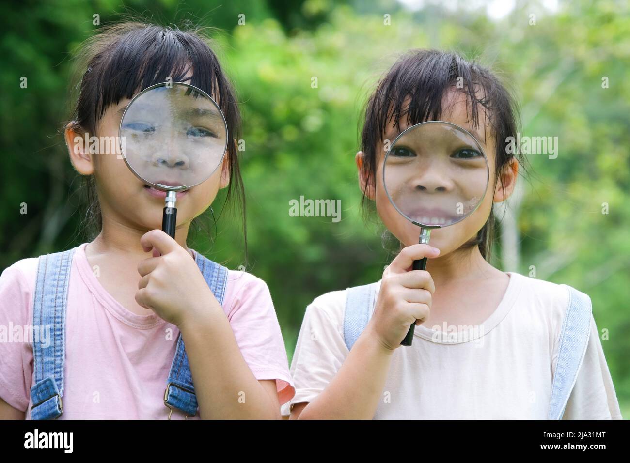 Children learn and explore nature with an outdoor magnifying glass ...