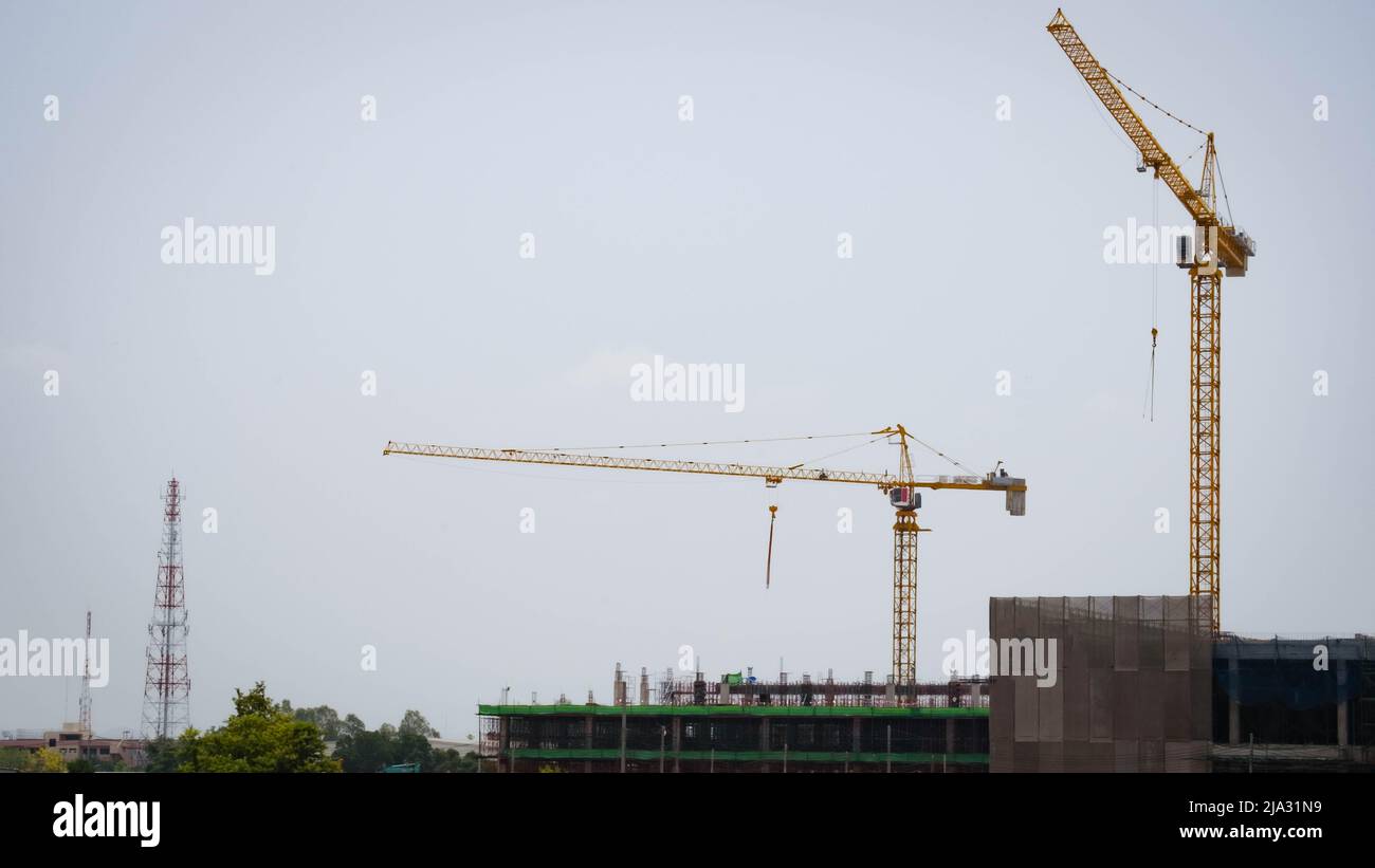 A large construction site with busy cranes. Tower cranes working on a ...