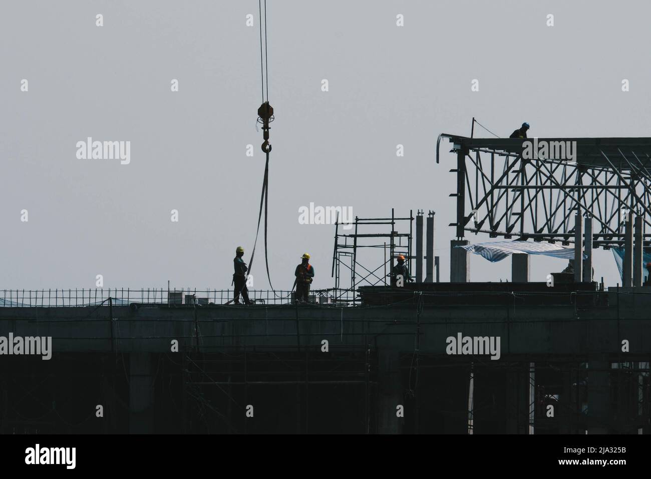 A large construction site with busy cranes. Tower cranes working on a ...