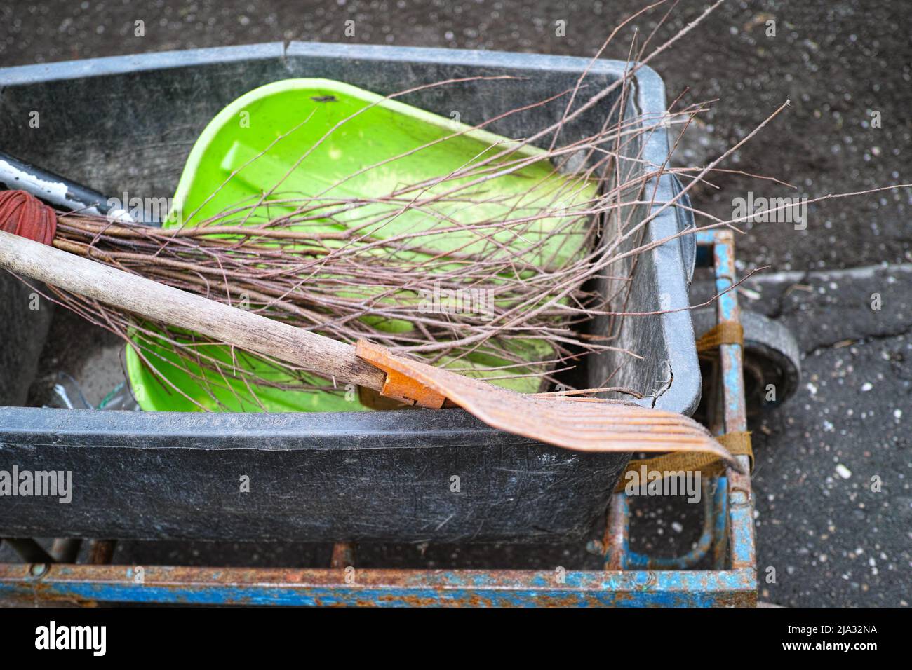 shovel, broom and brush in a trolley, outdoor close up Stock Photo - Alamy