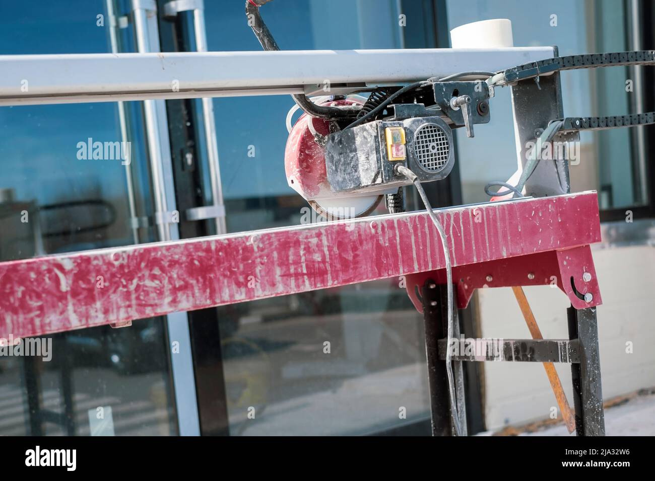 dusty and dirty electric tile cutter, outdoor sunny day shot Stock ...