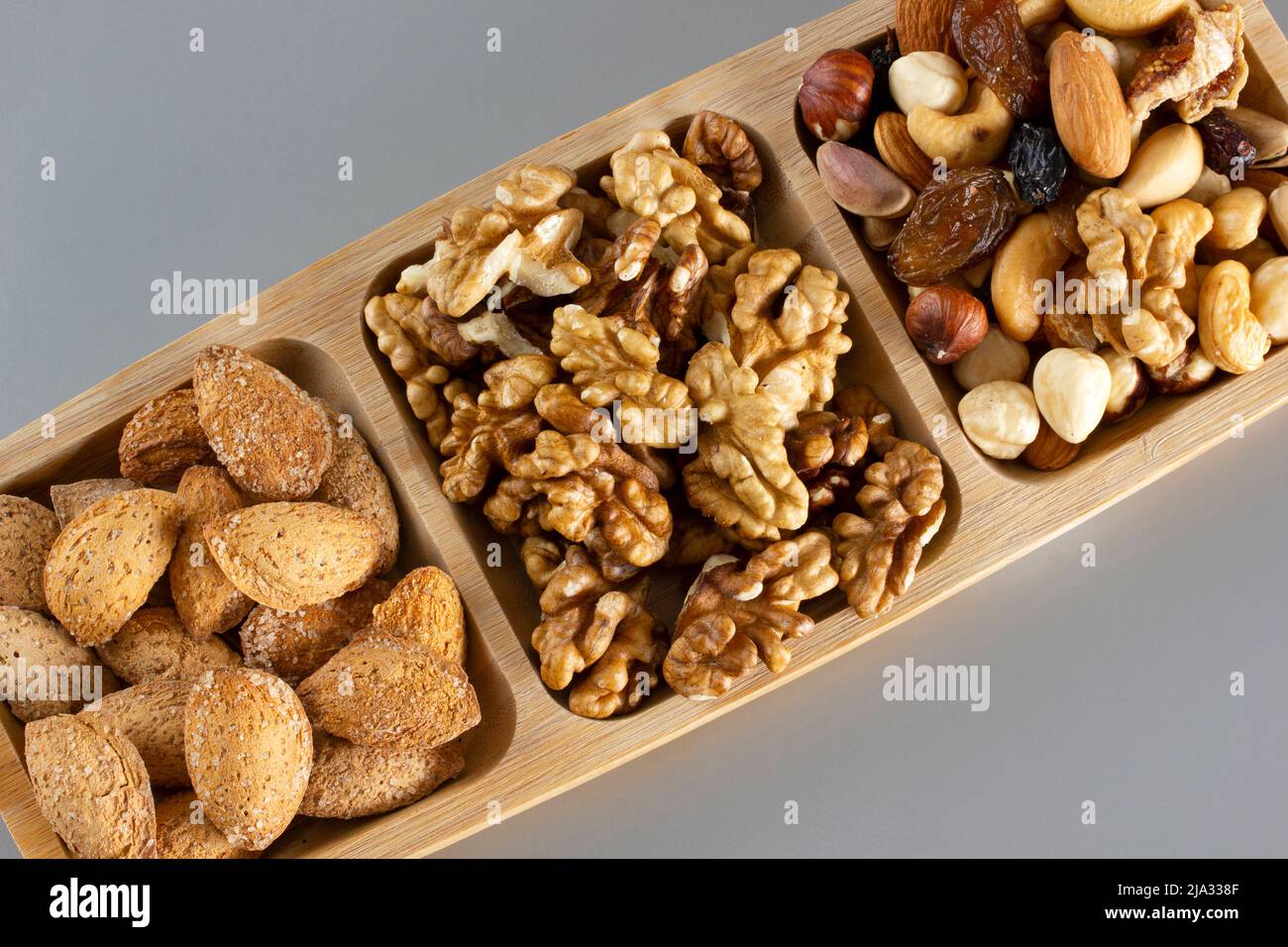 mixed nuts in a bamboo plate Stock Photo - Alamy