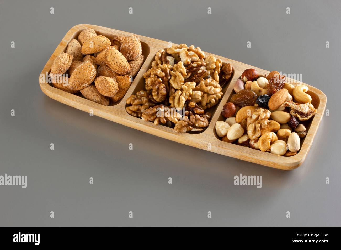 mixed nuts in a bamboo plate Stock Photo - Alamy