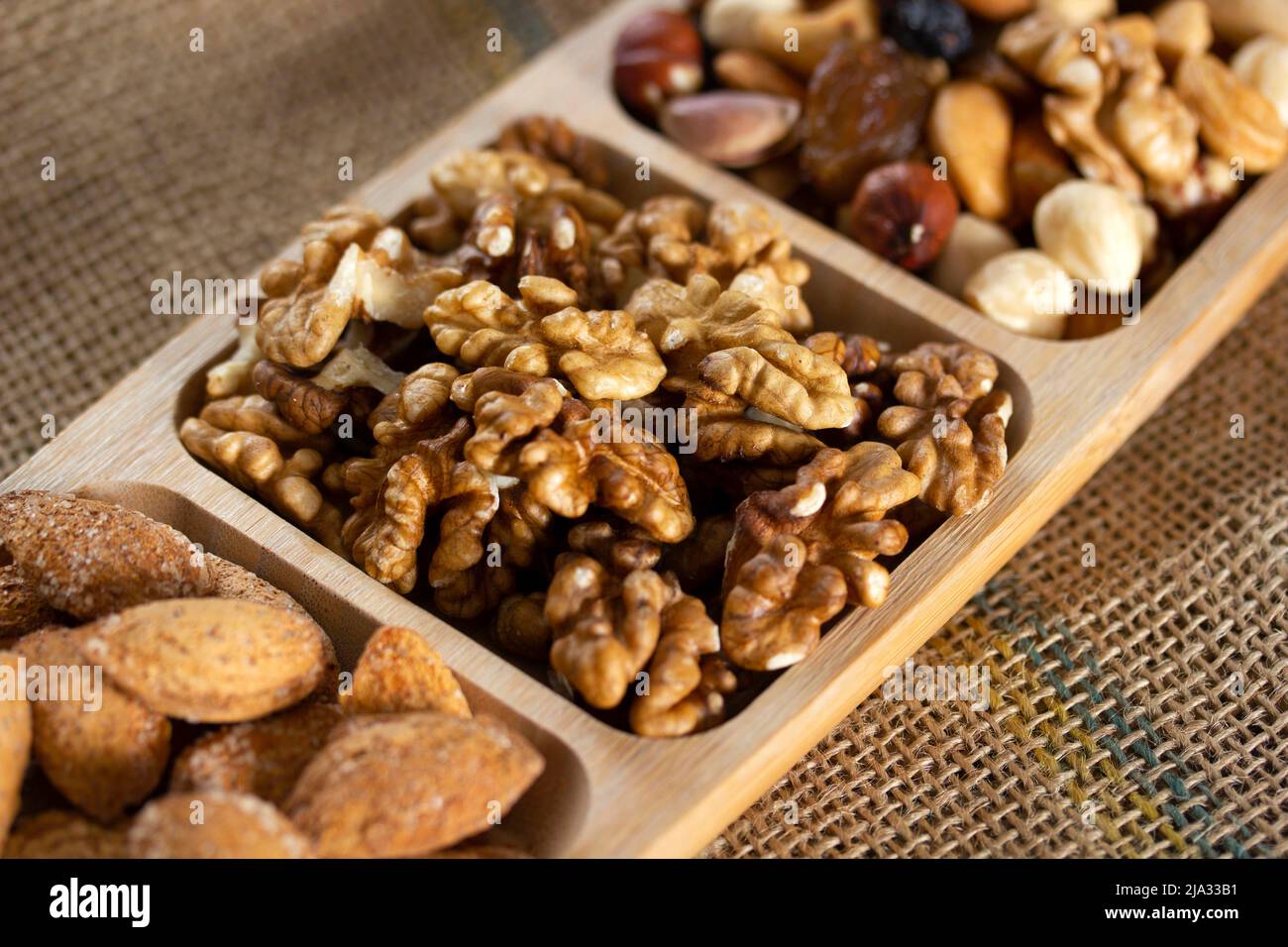 mixed nuts in a bamboo plate Stock Photo - Alamy