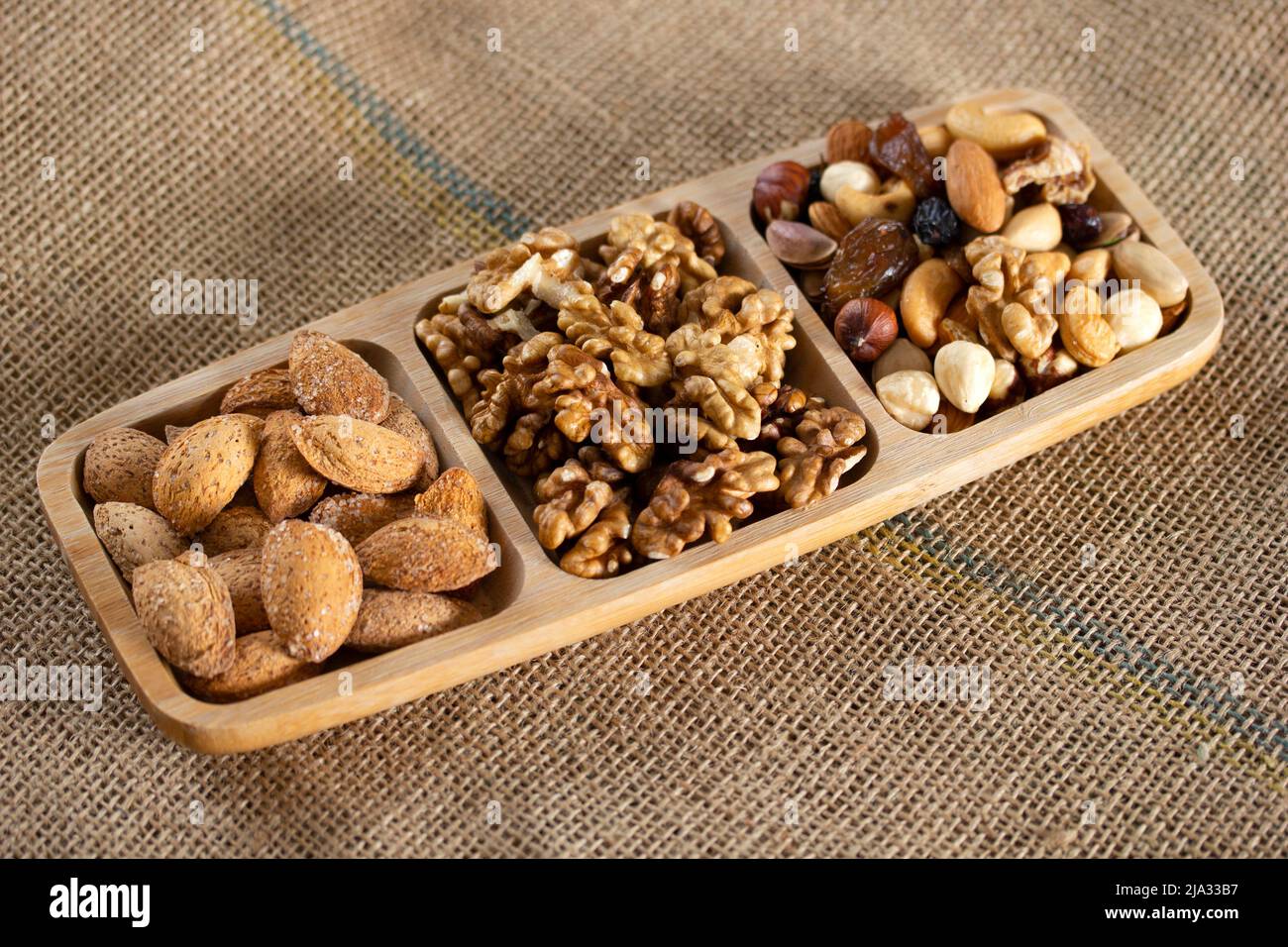 mixed nuts in a bamboo plate Stock Photo - Alamy