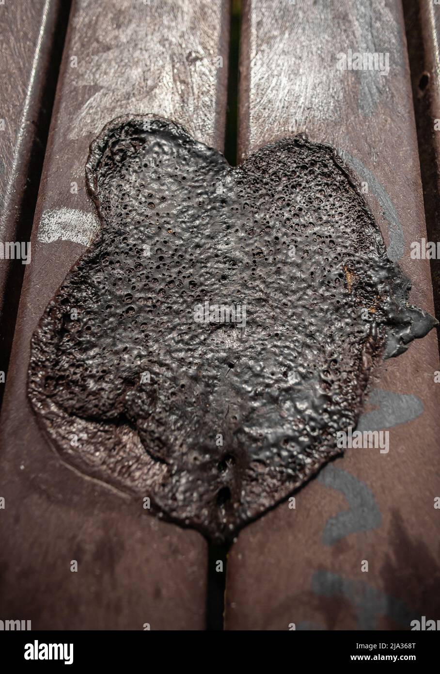 Close up of damaged surface of faux wood table Melted spot on ...