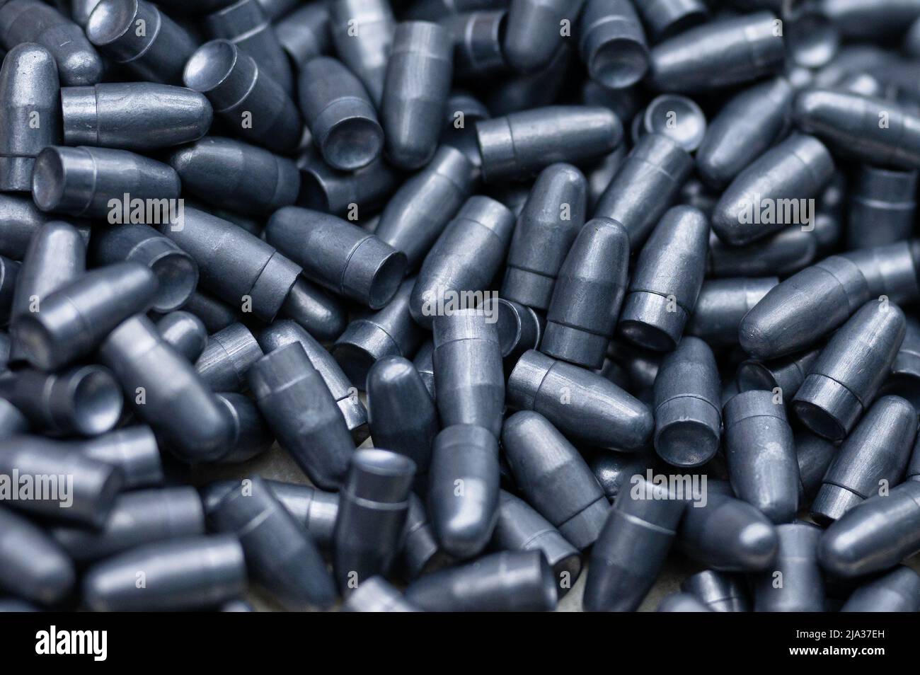 Grey small caliber hunter bullets as background closeup Stock Photo - Alamy