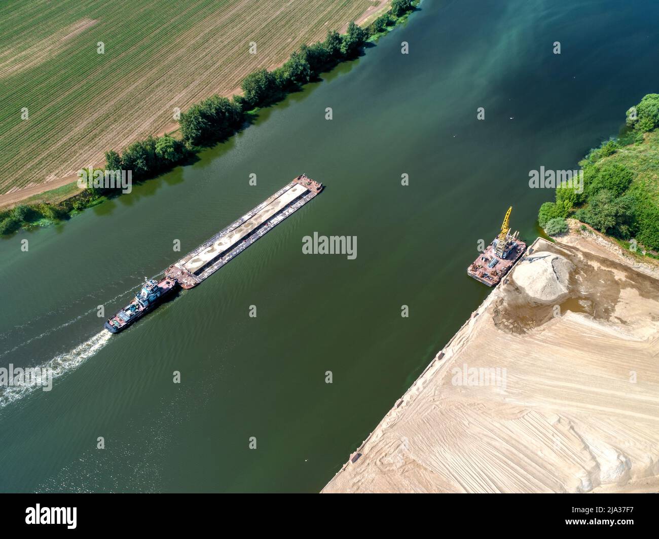 Cargo vessel near river terminal of sand and gravel loading Stock Photo ...
