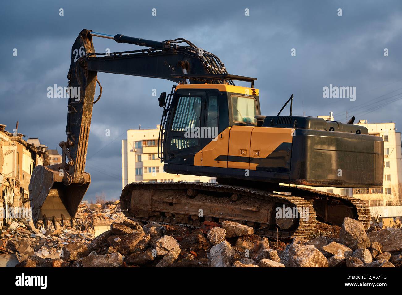 Building excavator on concrete pieces at demolition site Stock Photo ...