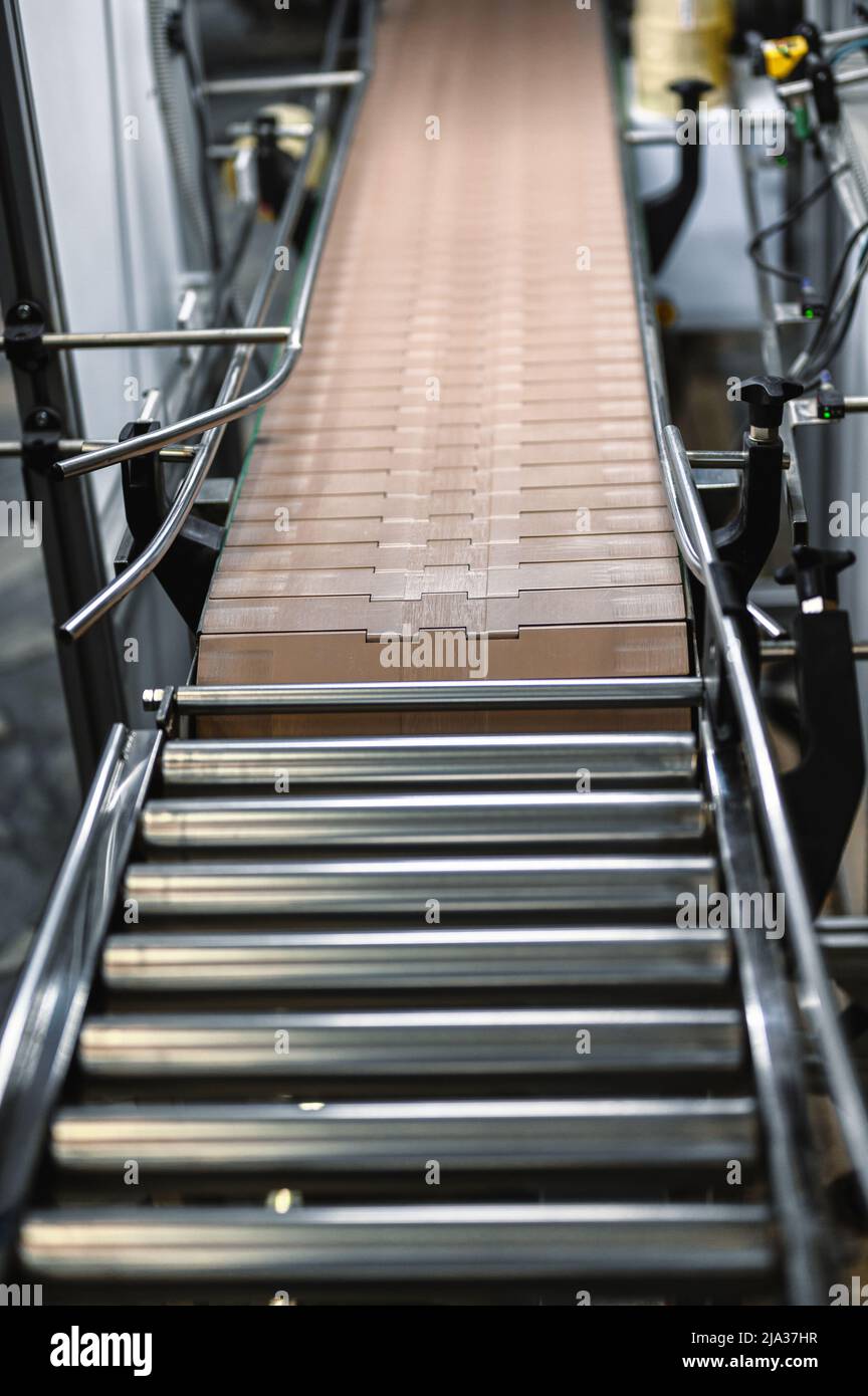 Empty conveyor belt with metal rollers in workshop Stock Photo - Alamy