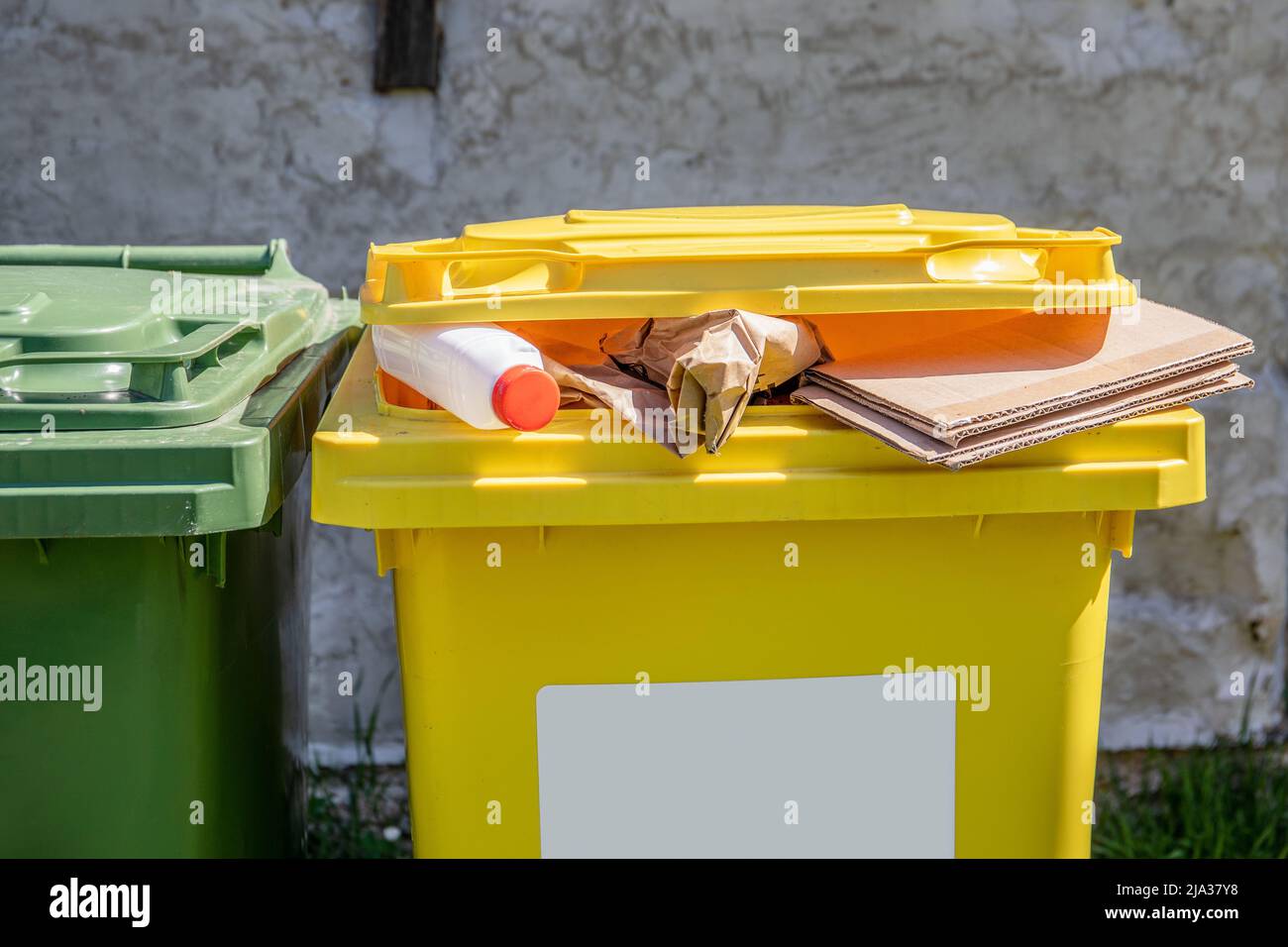 Overfilled sorted waste container. Waste collection and recycling Stock ...