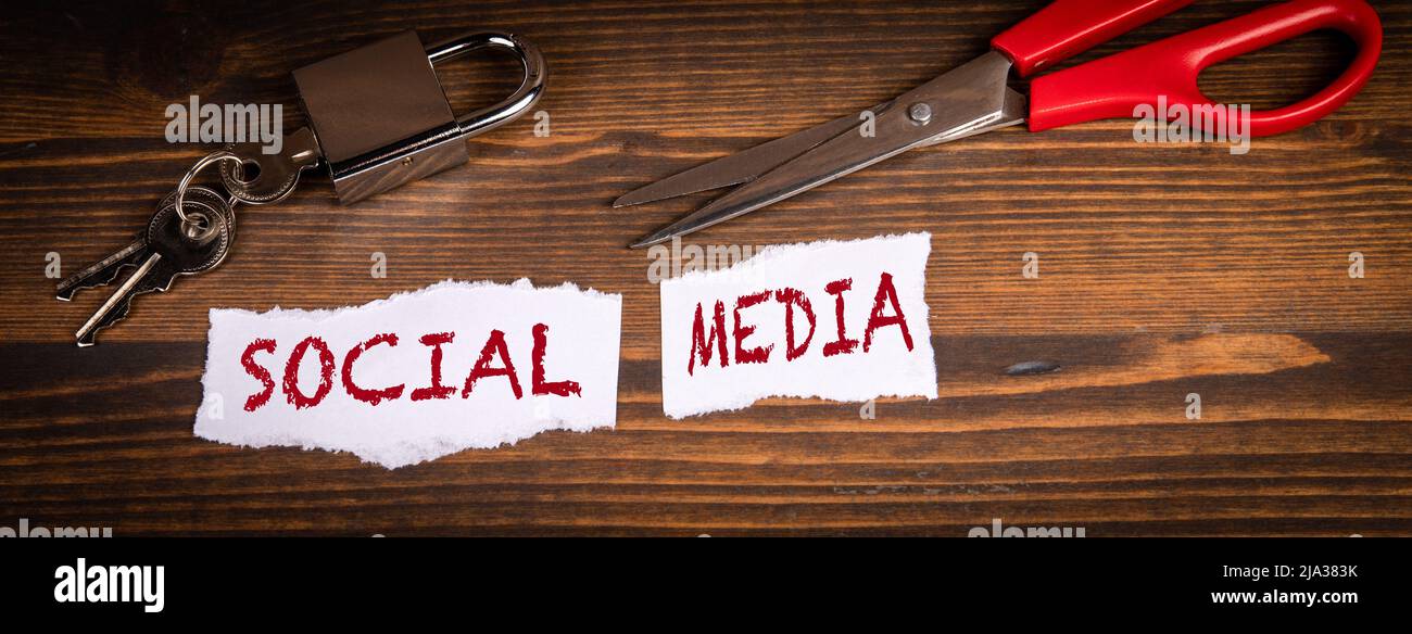 Social Media Business concept. Scissors and padlock on a wooden ...