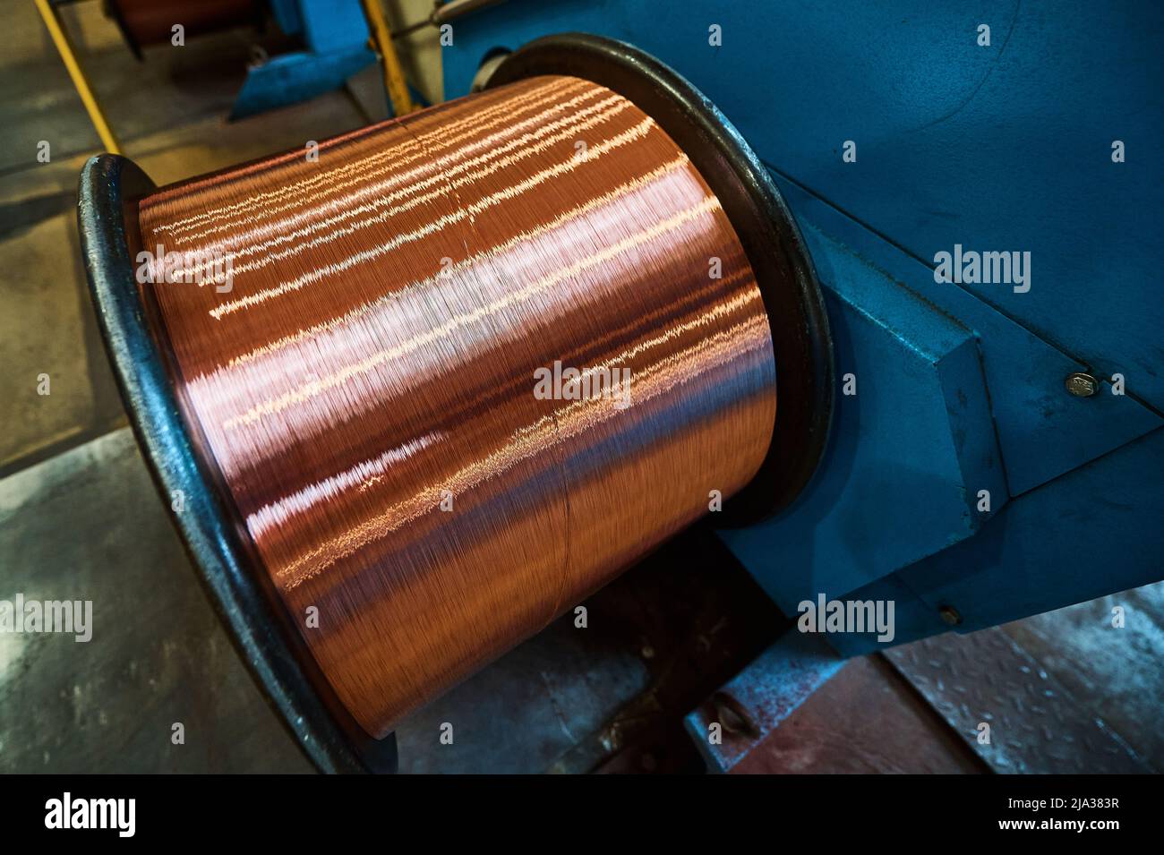 Coiling shiny copper cable onto reels to package at plant Stock Photo ...