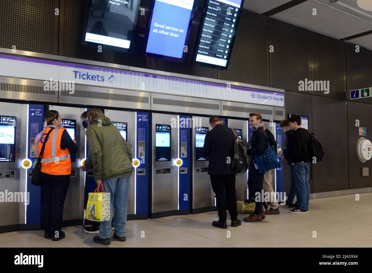 Transport for London staff helping passengers buy tickets at the new ...