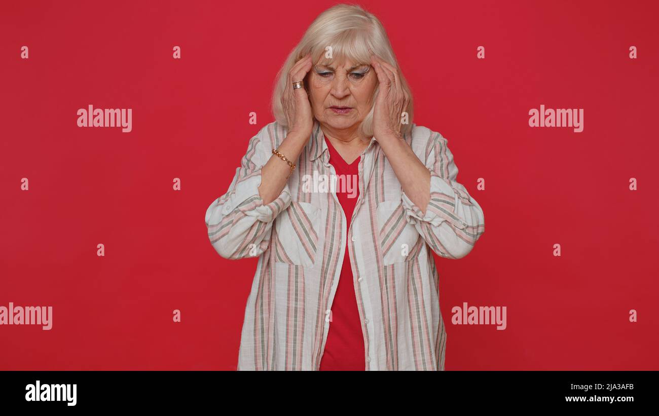 Senior woman rubbing temples to cure headache problem suffering from ...