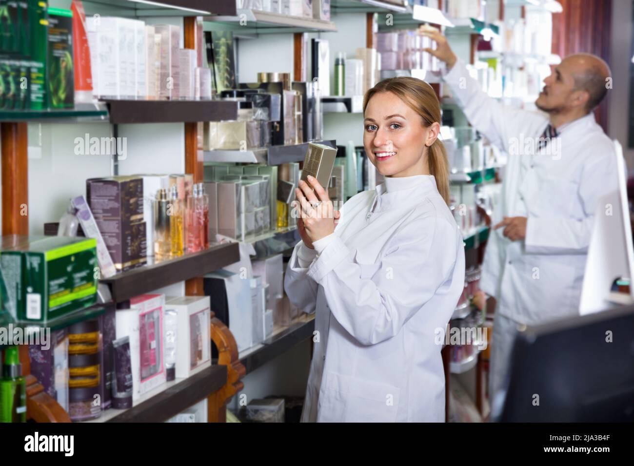 Female and male pharmacists working the pharmaceutical store Stock ...