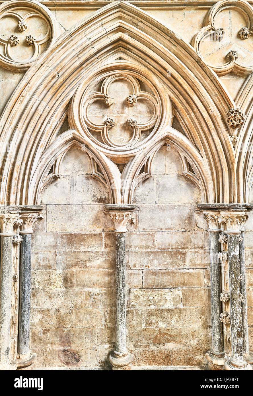 Decorated stone arches on a wall in the christian medieval cathedral at ...