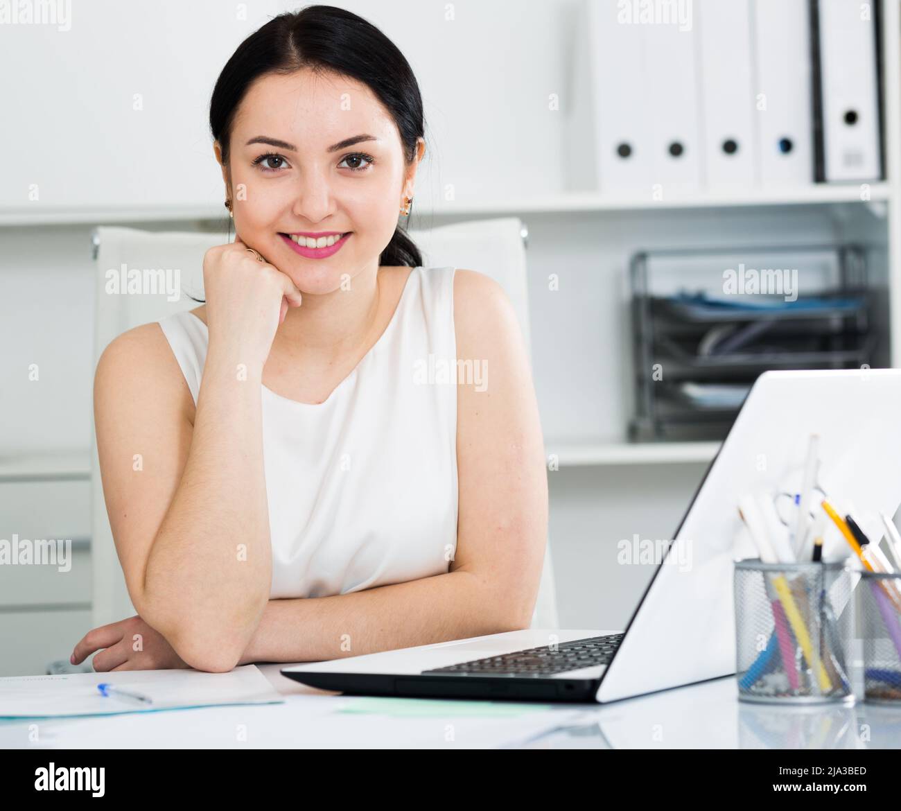 Woman posing in office Stock Photo - Alamy