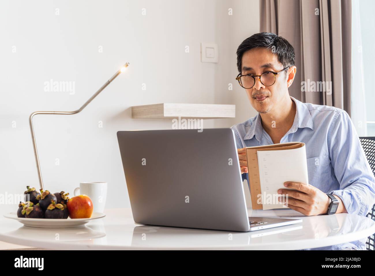 Businessman holding glasses analyzing hi-res stock photography and ...