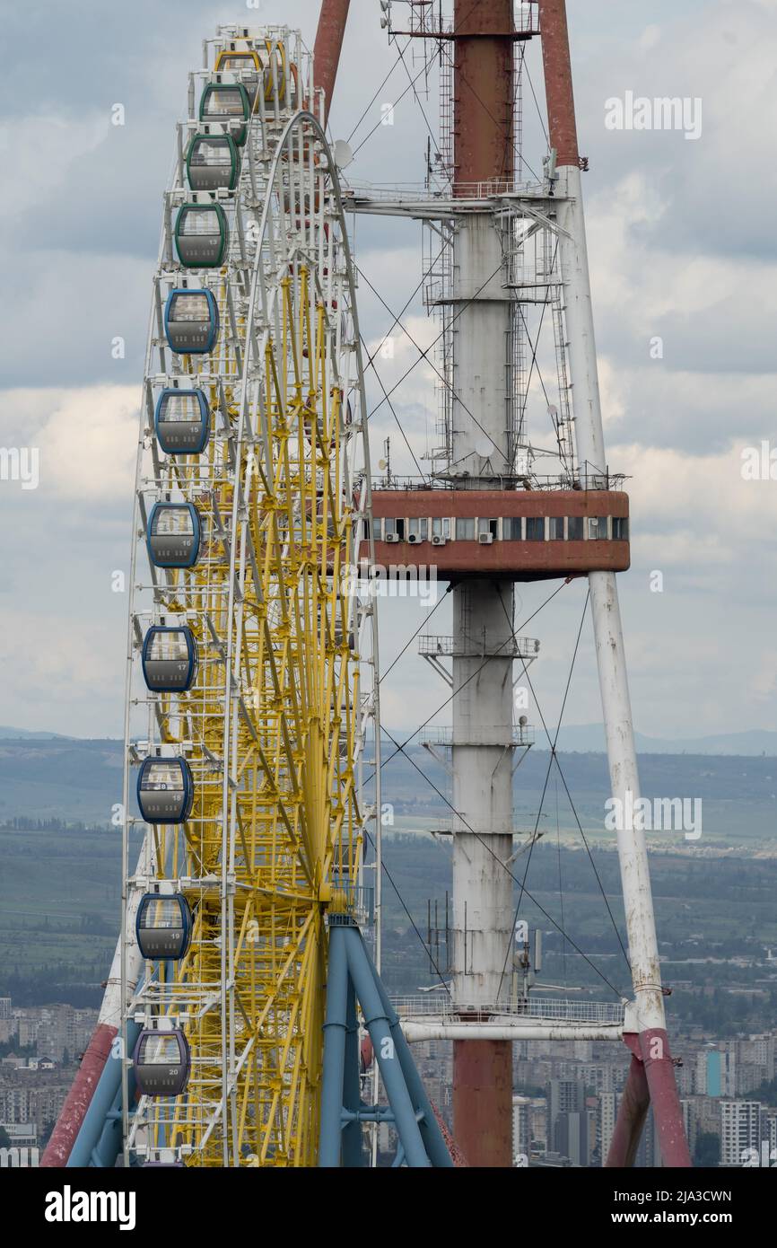 Closeup view of Ferris wheel in Tbilisi Georgia over television tower ...